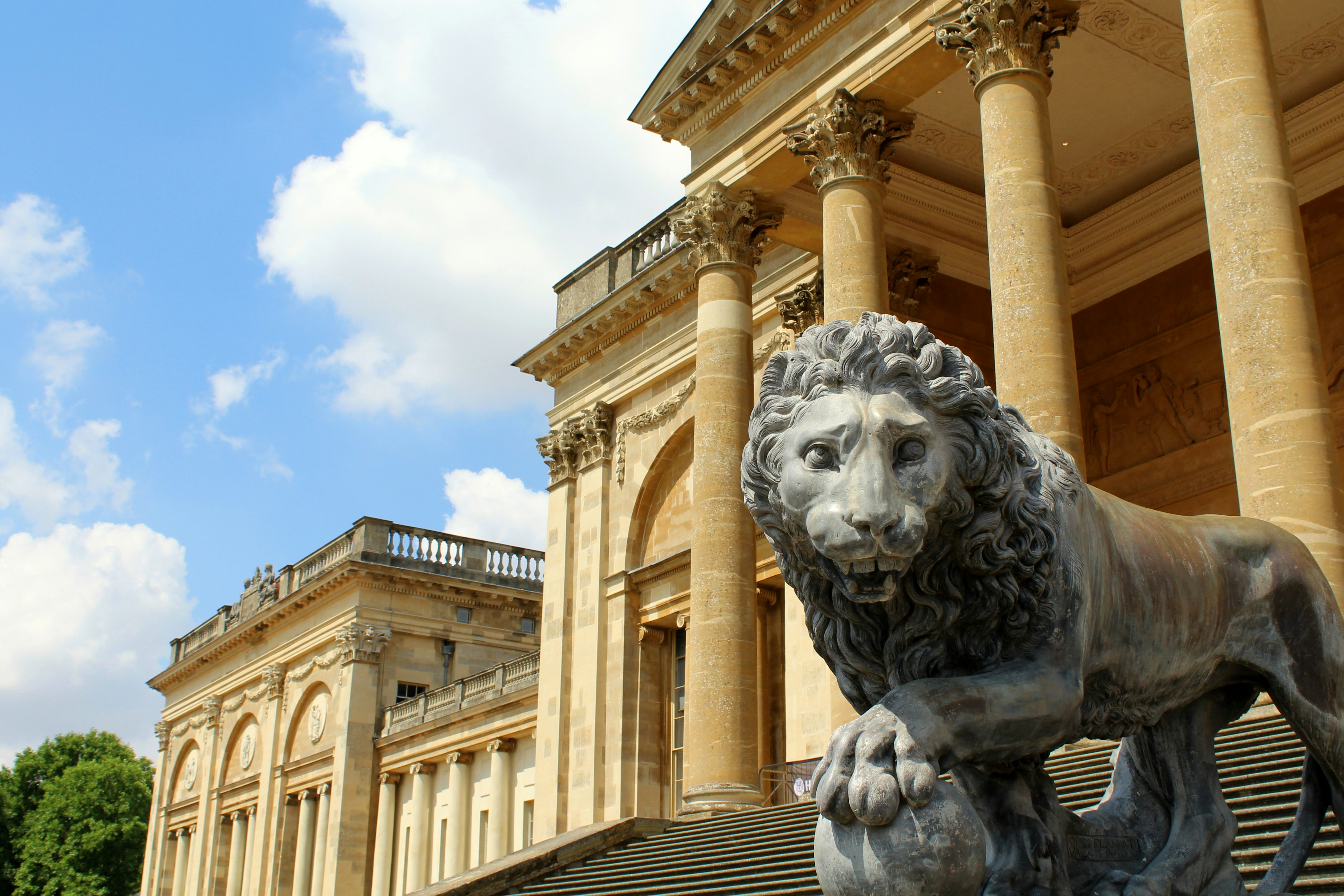 A statue of a lion in front of a building photo – Free Lion Image on ...