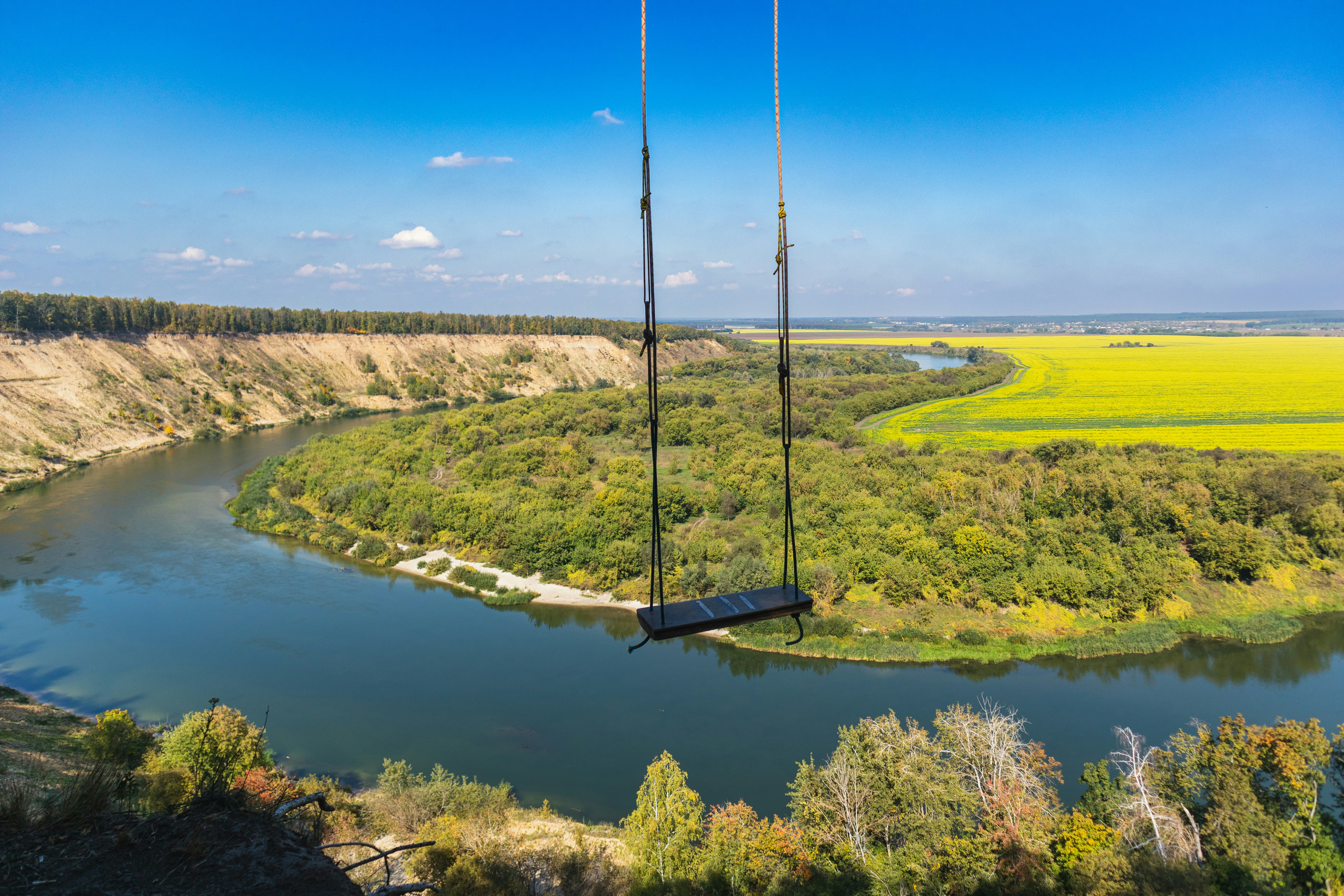 Suspended Swing Over a Golden River Bend