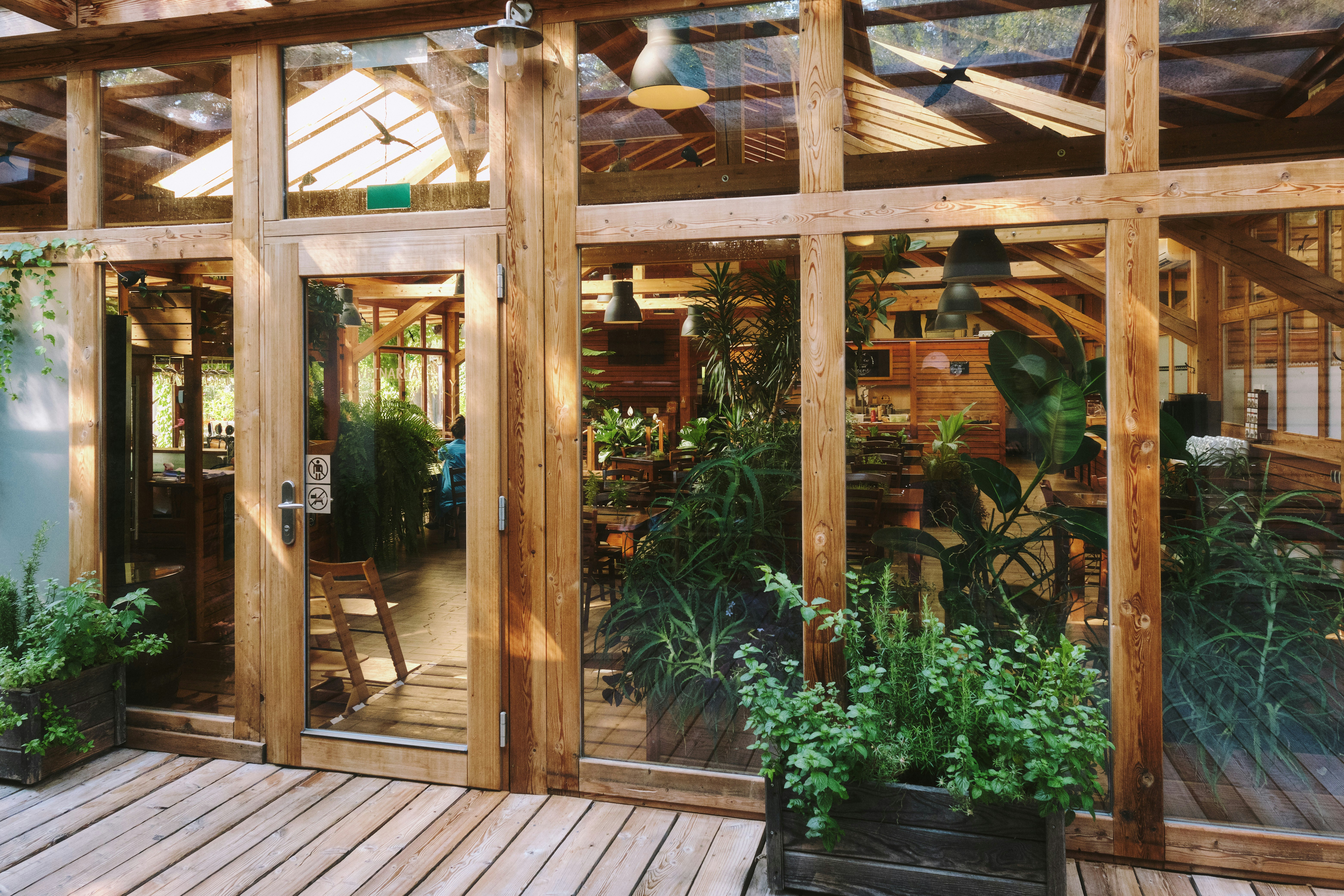 A room with a lot of plants inside of it photo – Free Bled Image on ...
