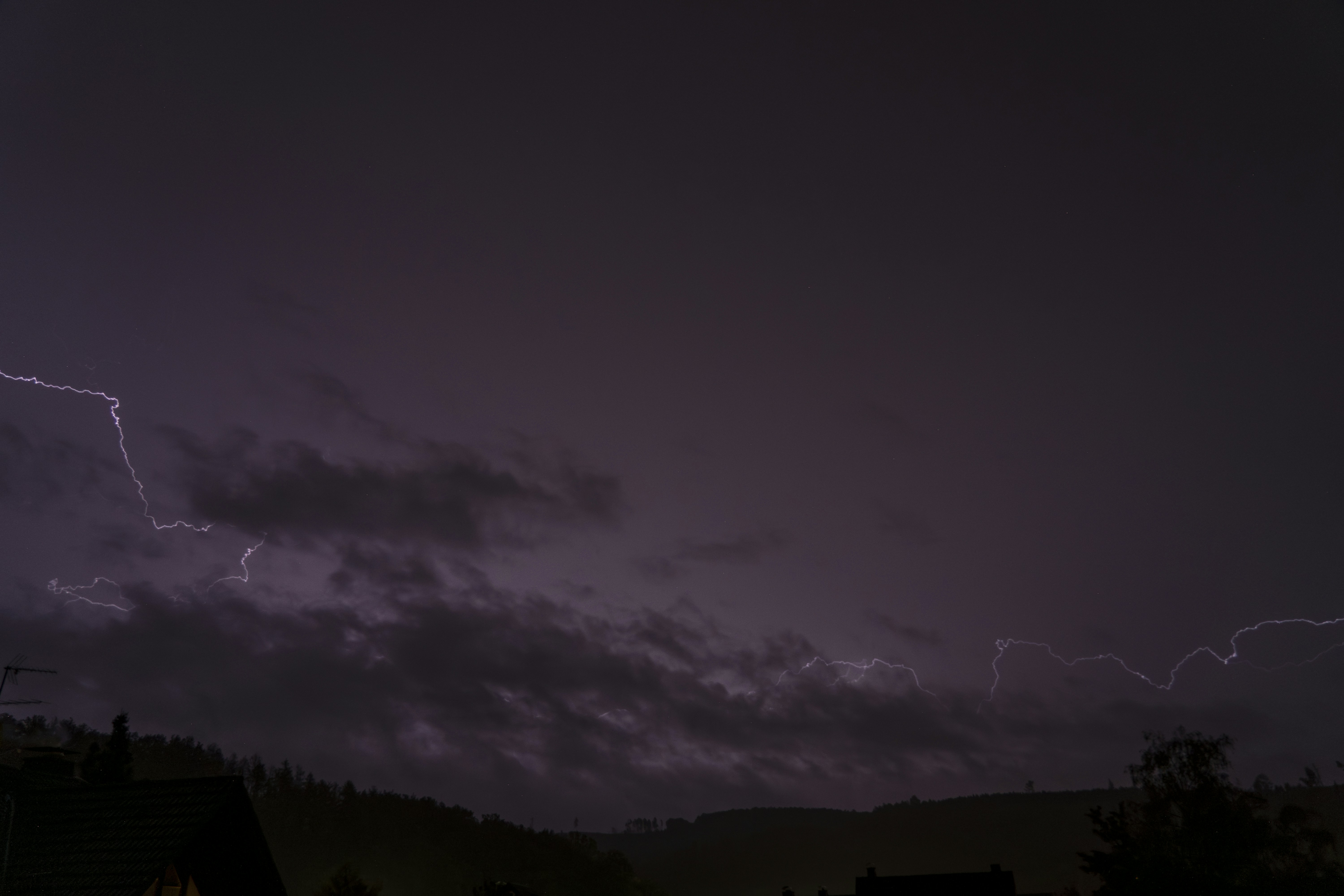 A dark sky with a lightning bolt in the distance photo – Free Nature ...