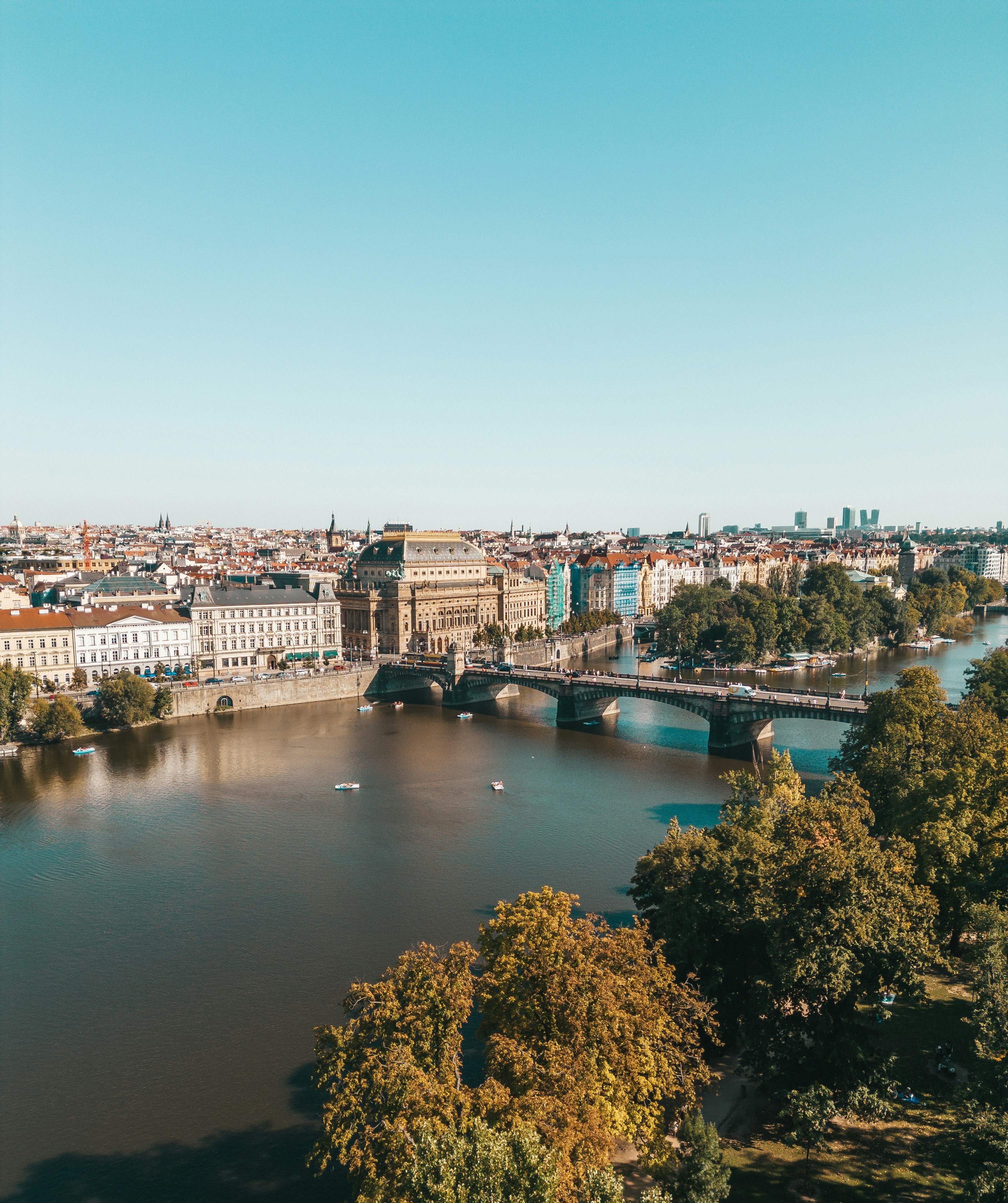 A river running through a city next to a bridge photo – Free Praha ...