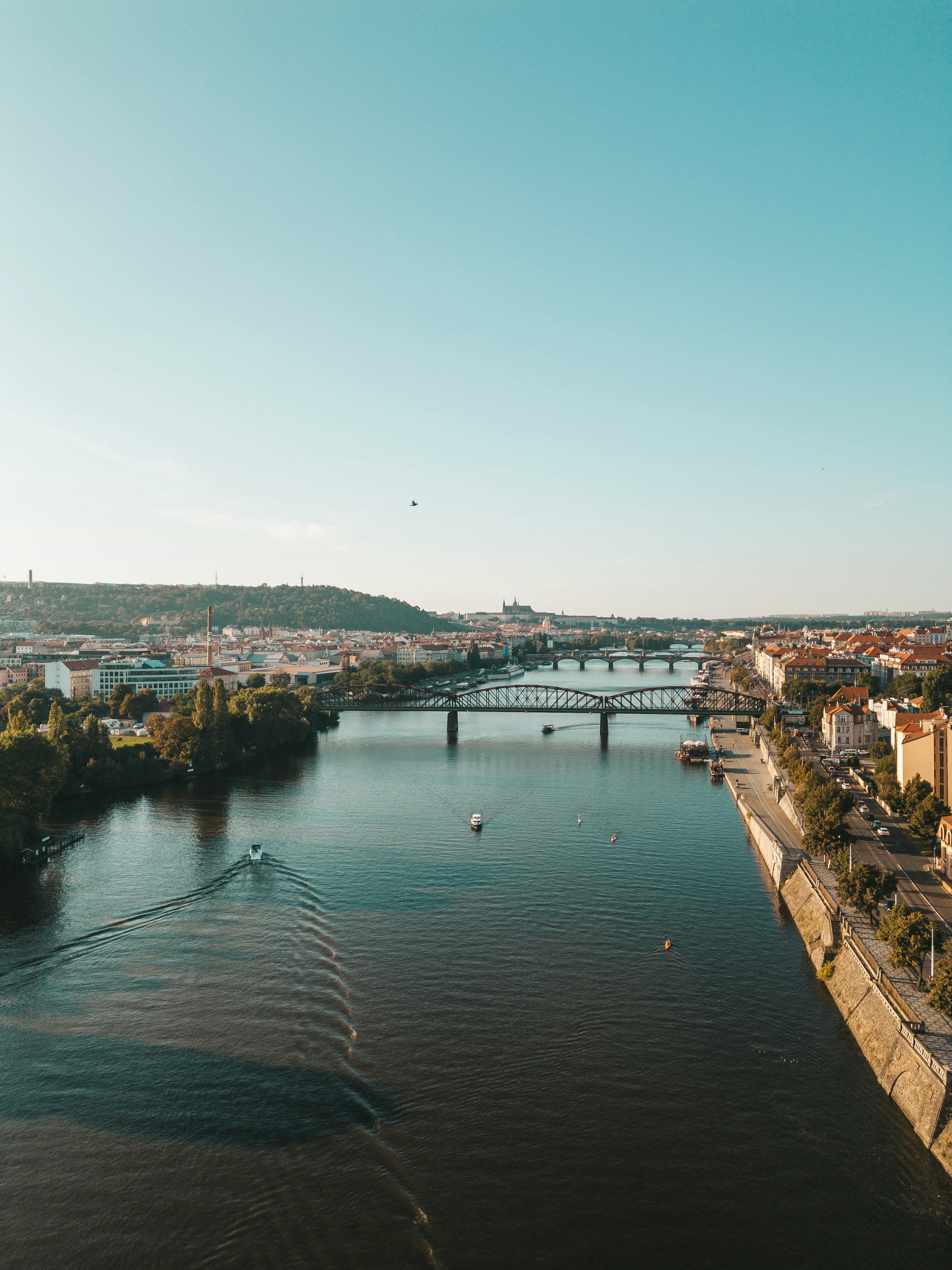 A river running through a city next to a bridge photo – Free Praha ...