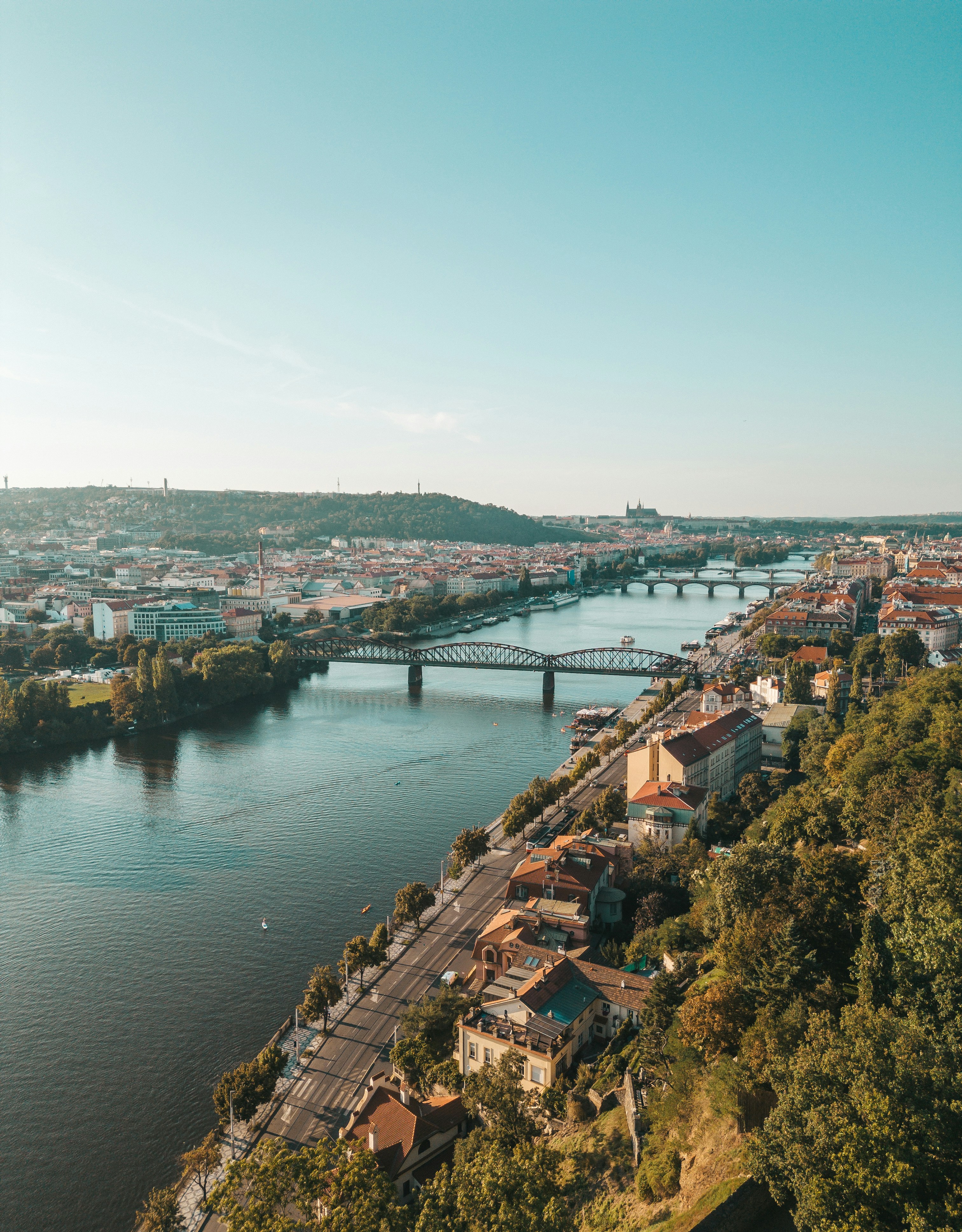 A view of a river with a bridge in the background photo – Free Praha ...