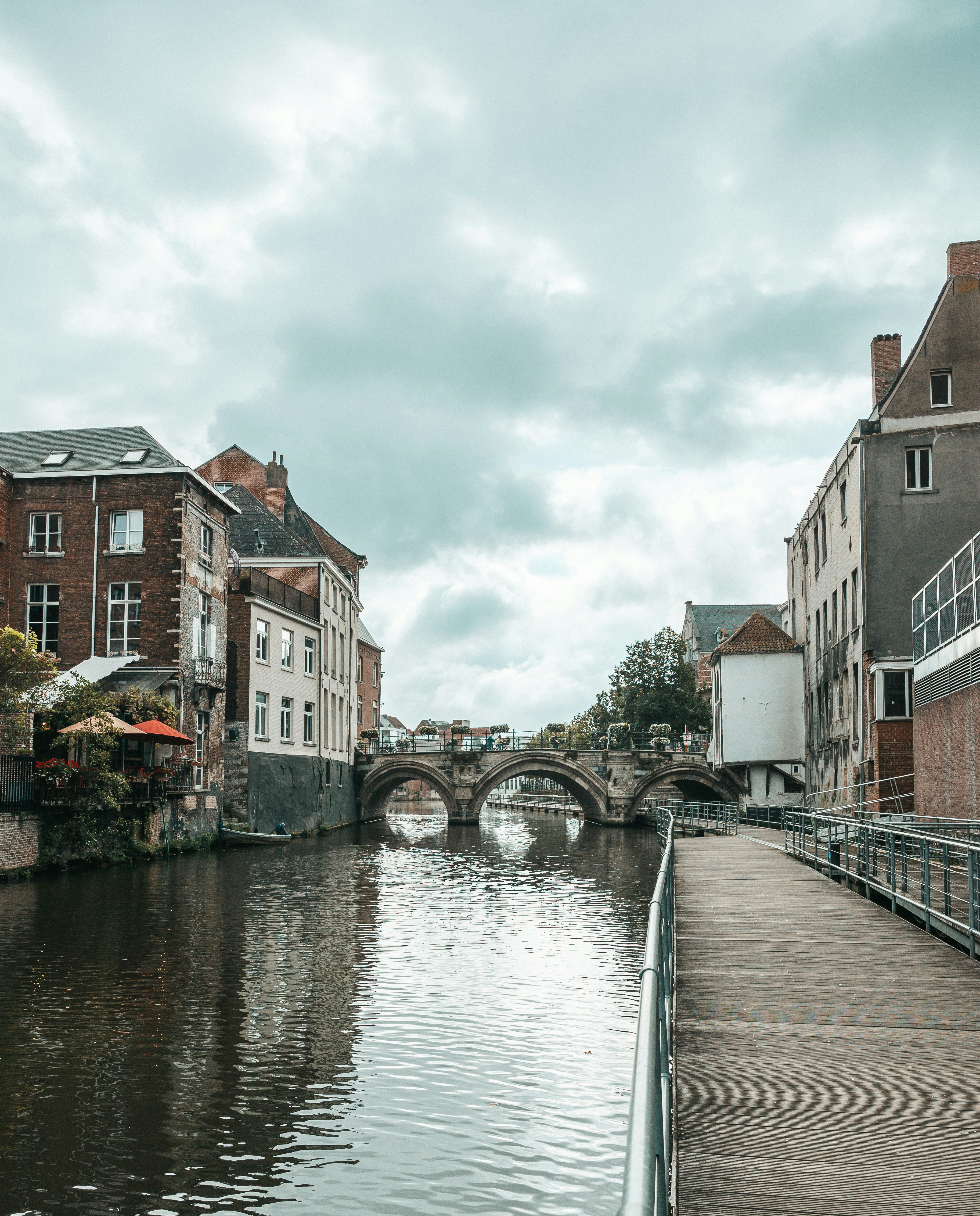 A river running through a city next to tall buildings photo – Free ...