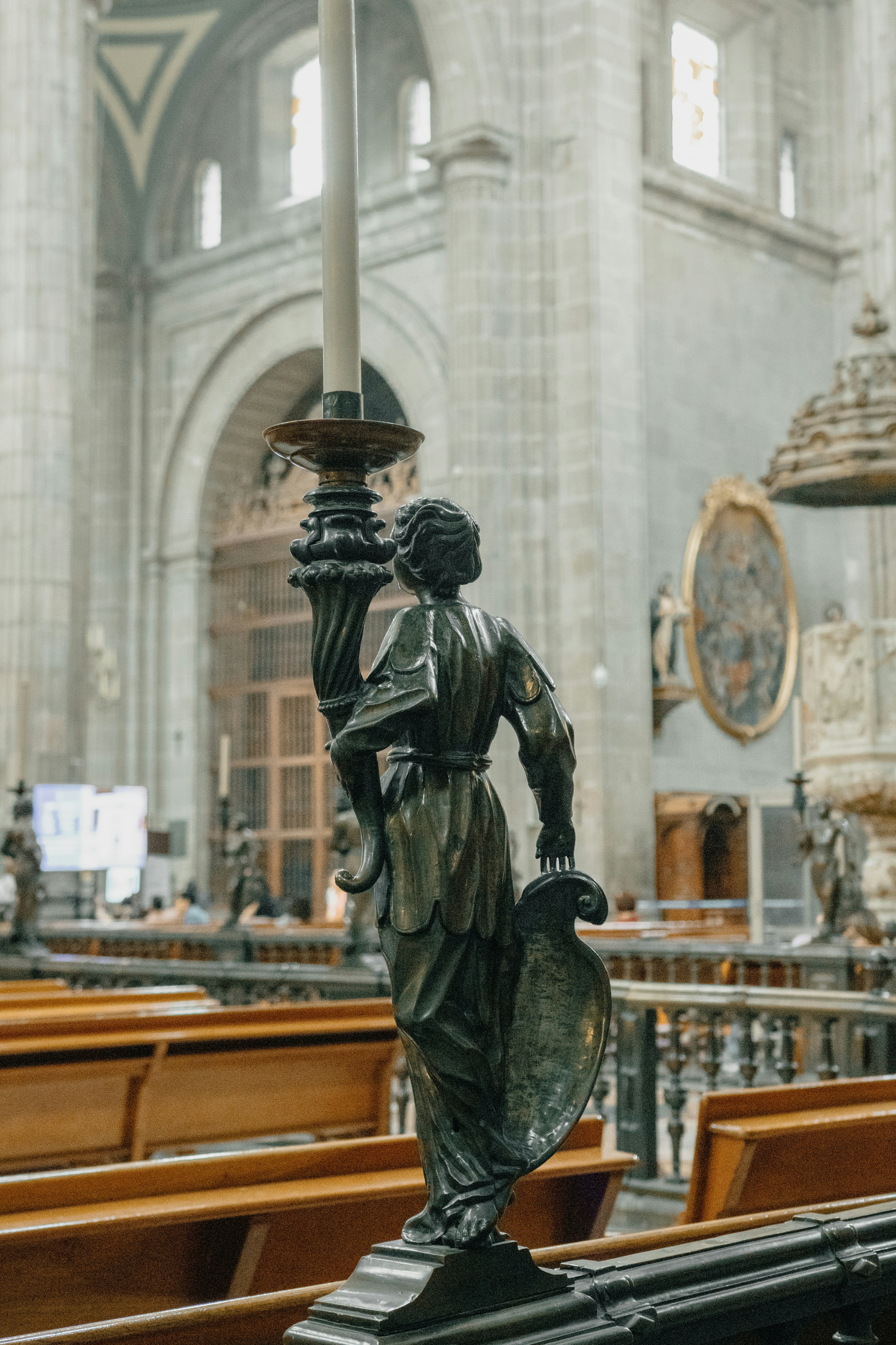 Candlelit Bronze Sentinel in a Gothic Cathedral