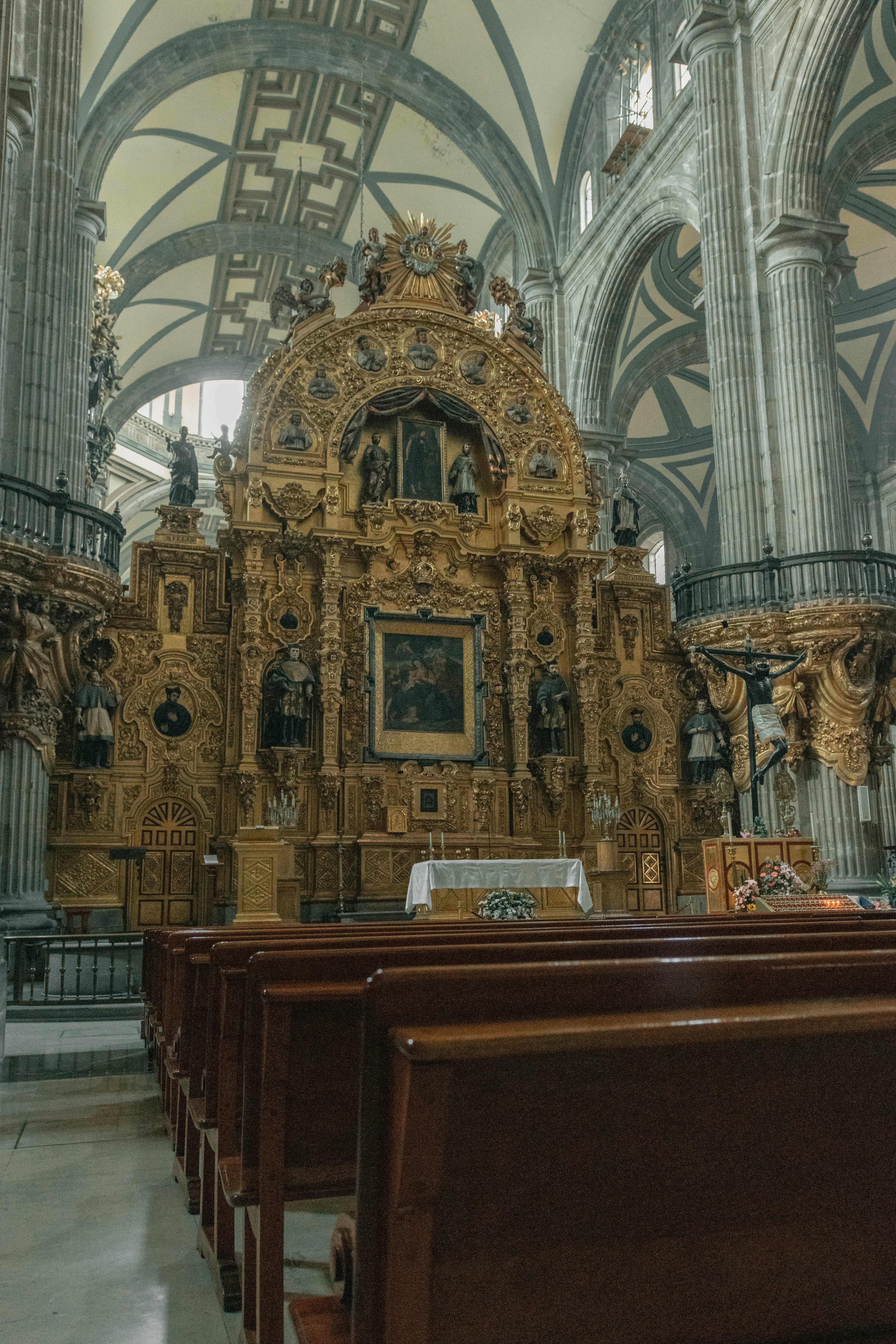 Centerpiece of Gold: A Baroque Altarpiece Framed by Gothic Vaults in a Cathedral Nave