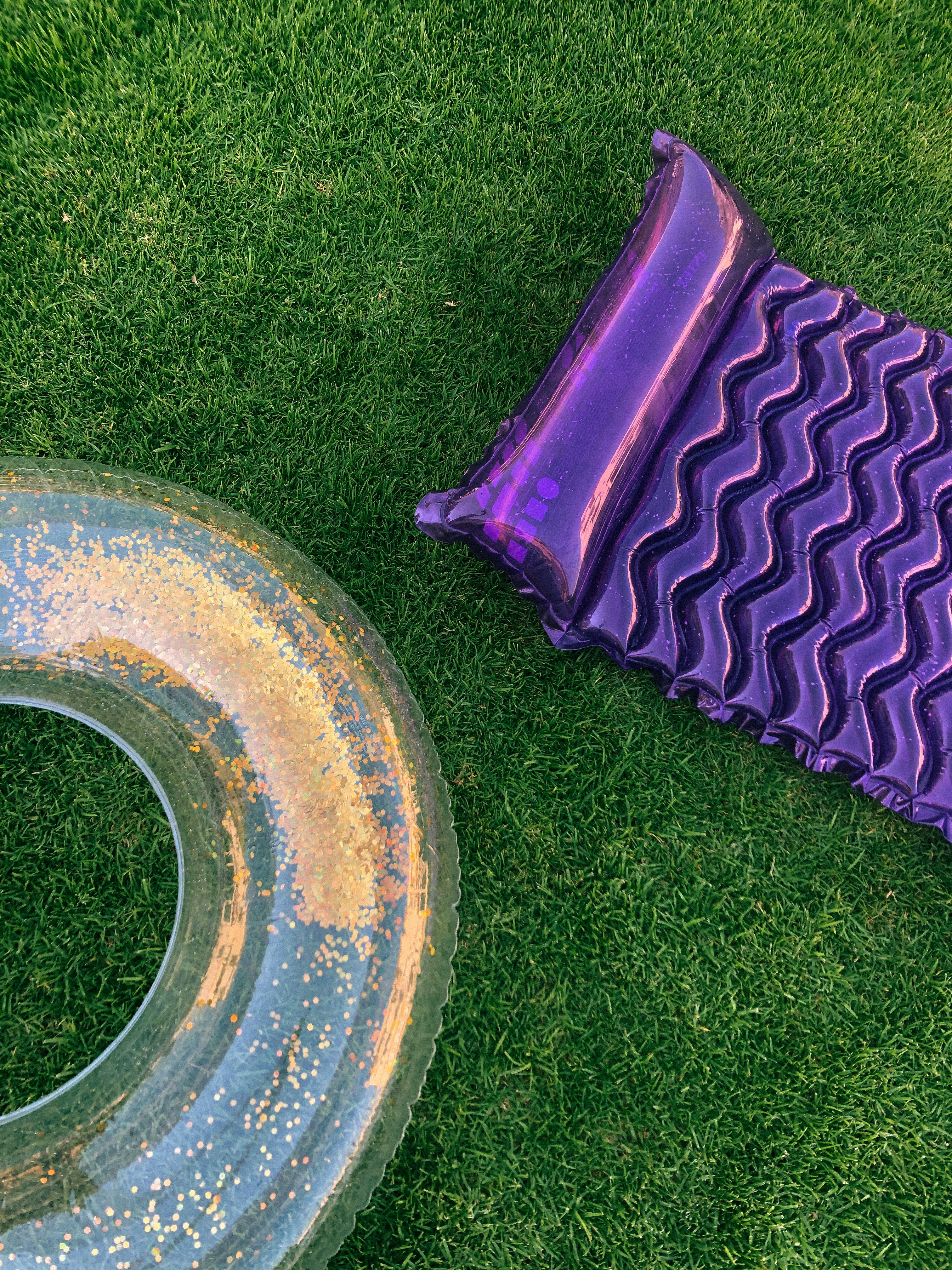A purple mat and a tire laying on the grass photo – Free Grass Image on ...