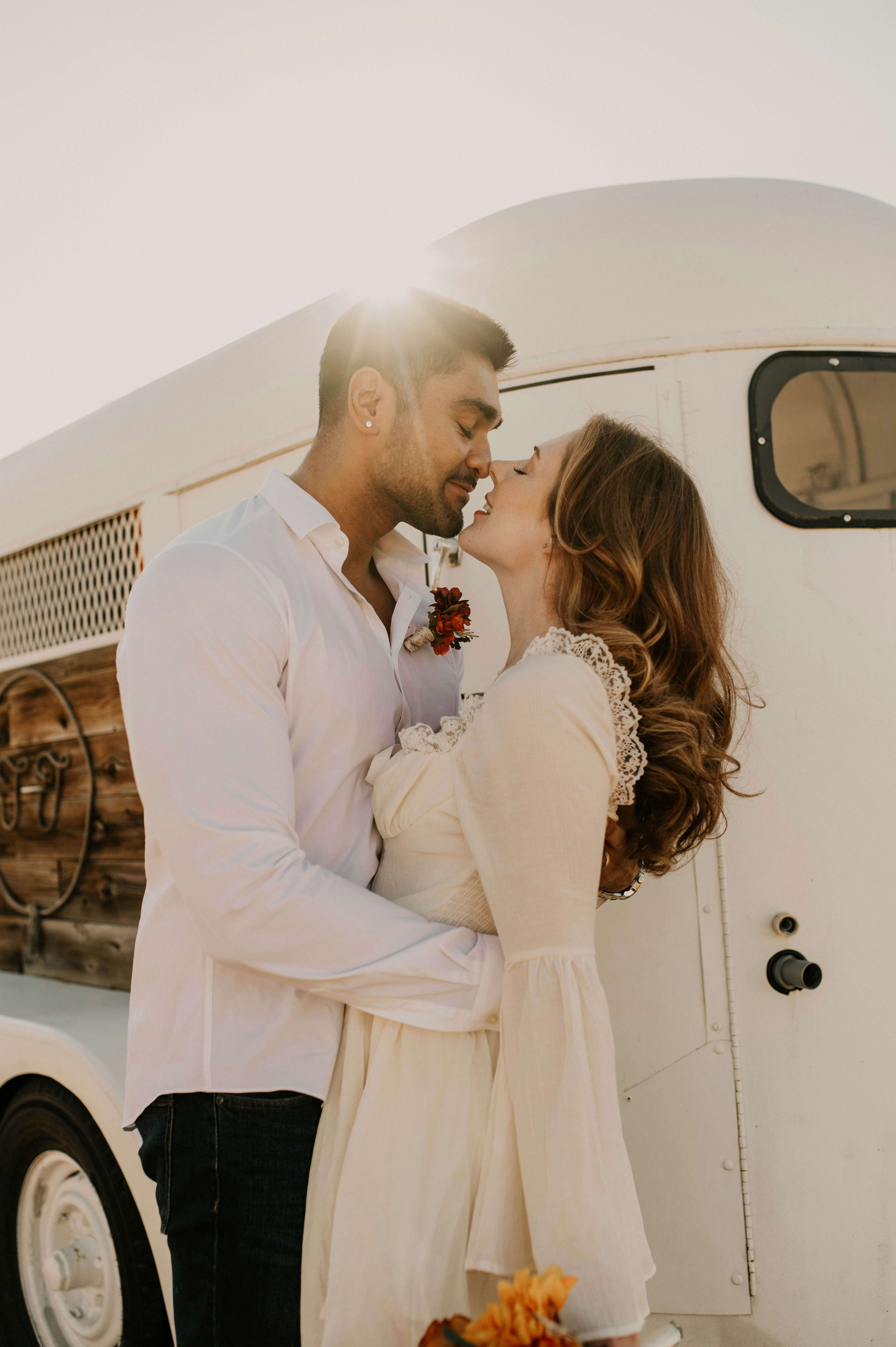 Golden Hour Embrace by a Retro Caravan
