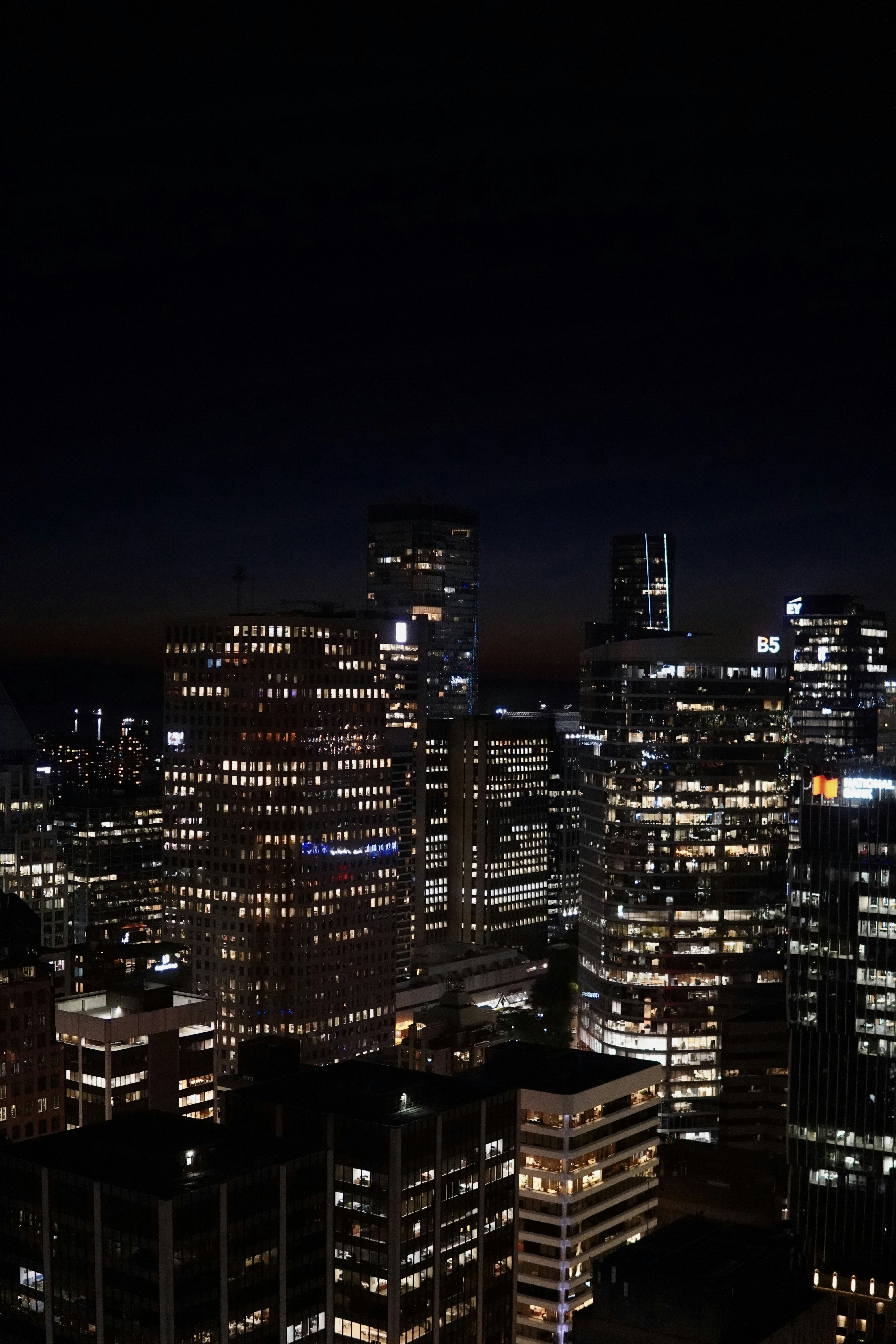 A view of a city at night from the top of a building photo – Free ...