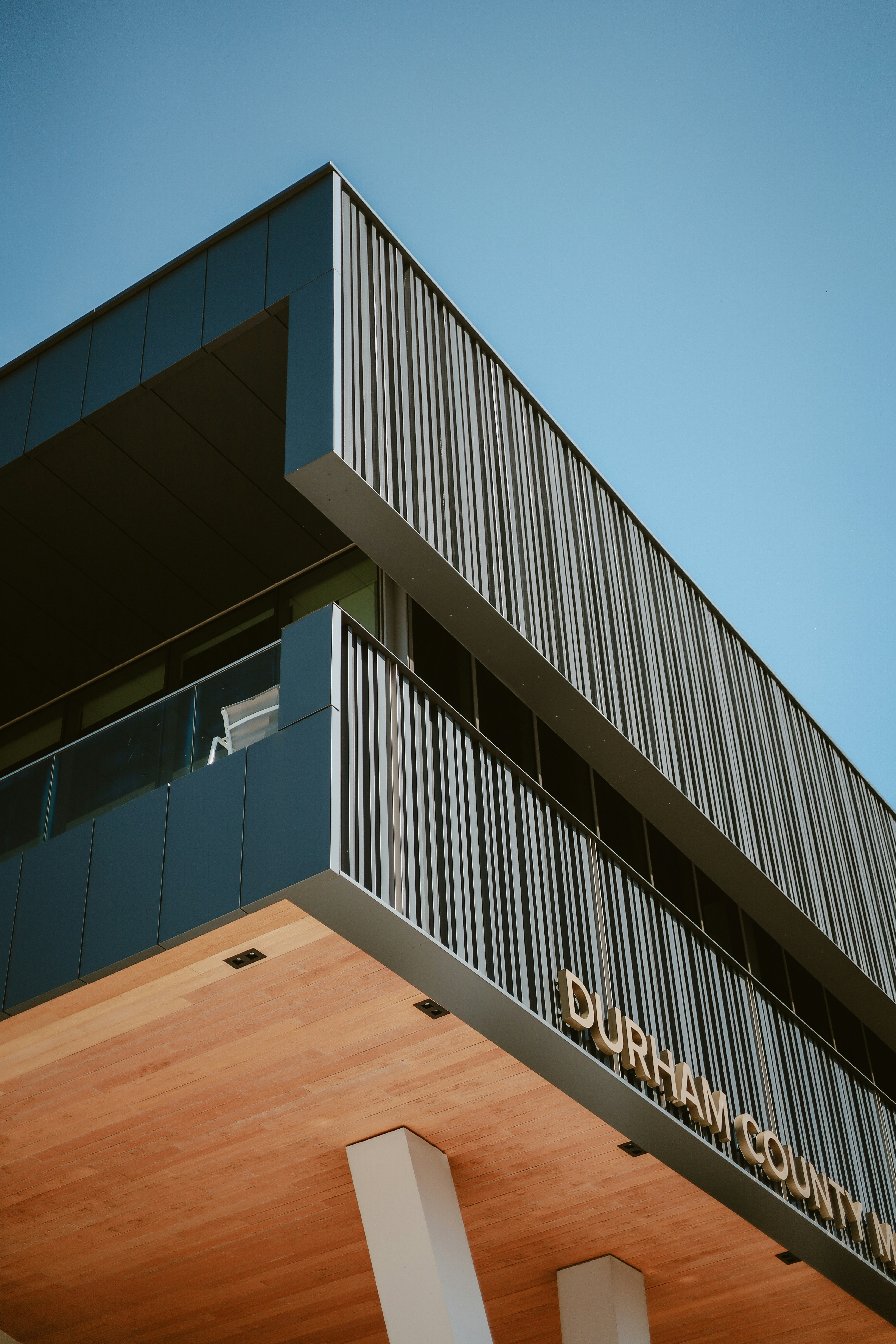 A tall building with a sign on the side of it photo – Free Durham Image ...