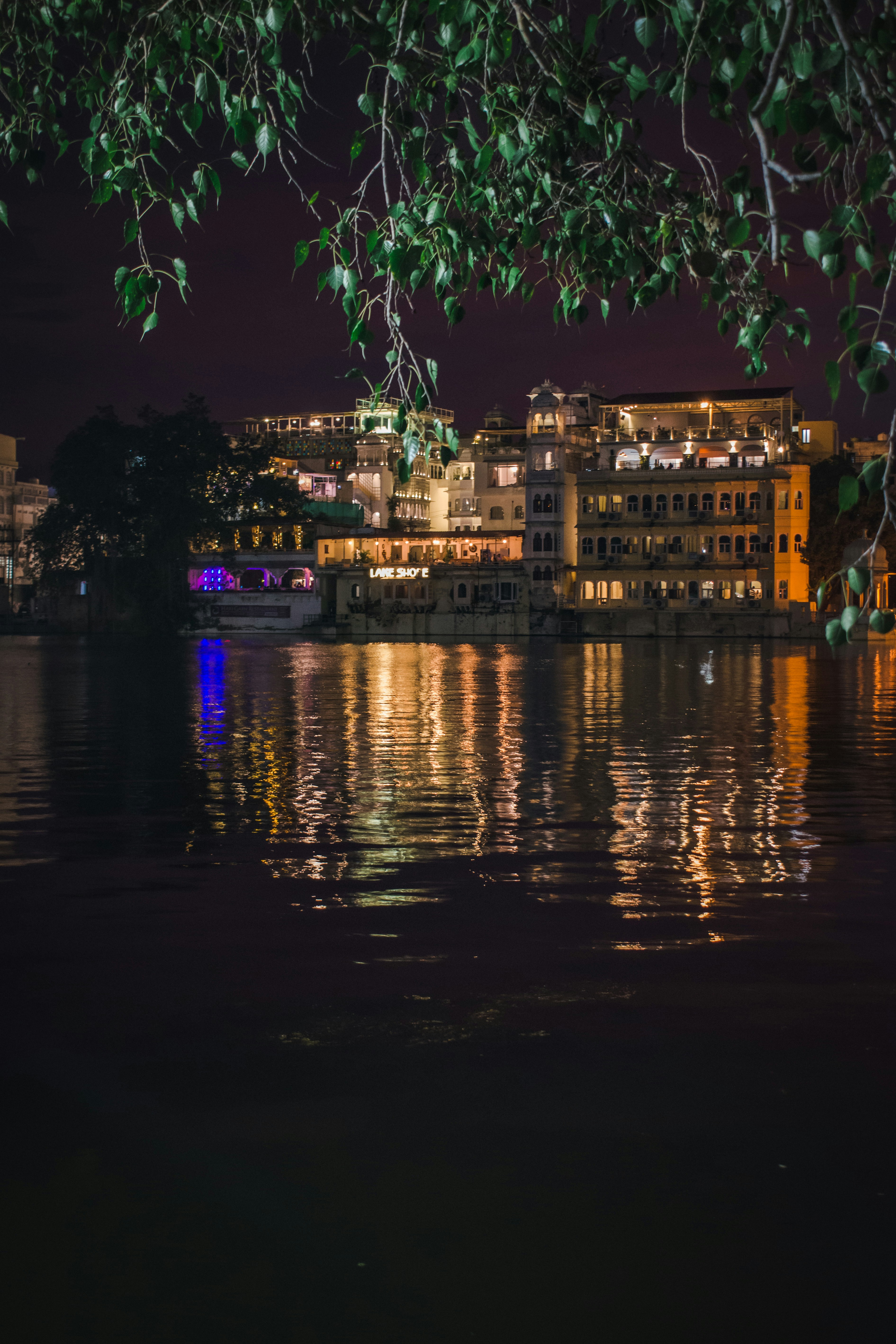 A night time view of a city and a lake photo – Free Night Image on Unsplash