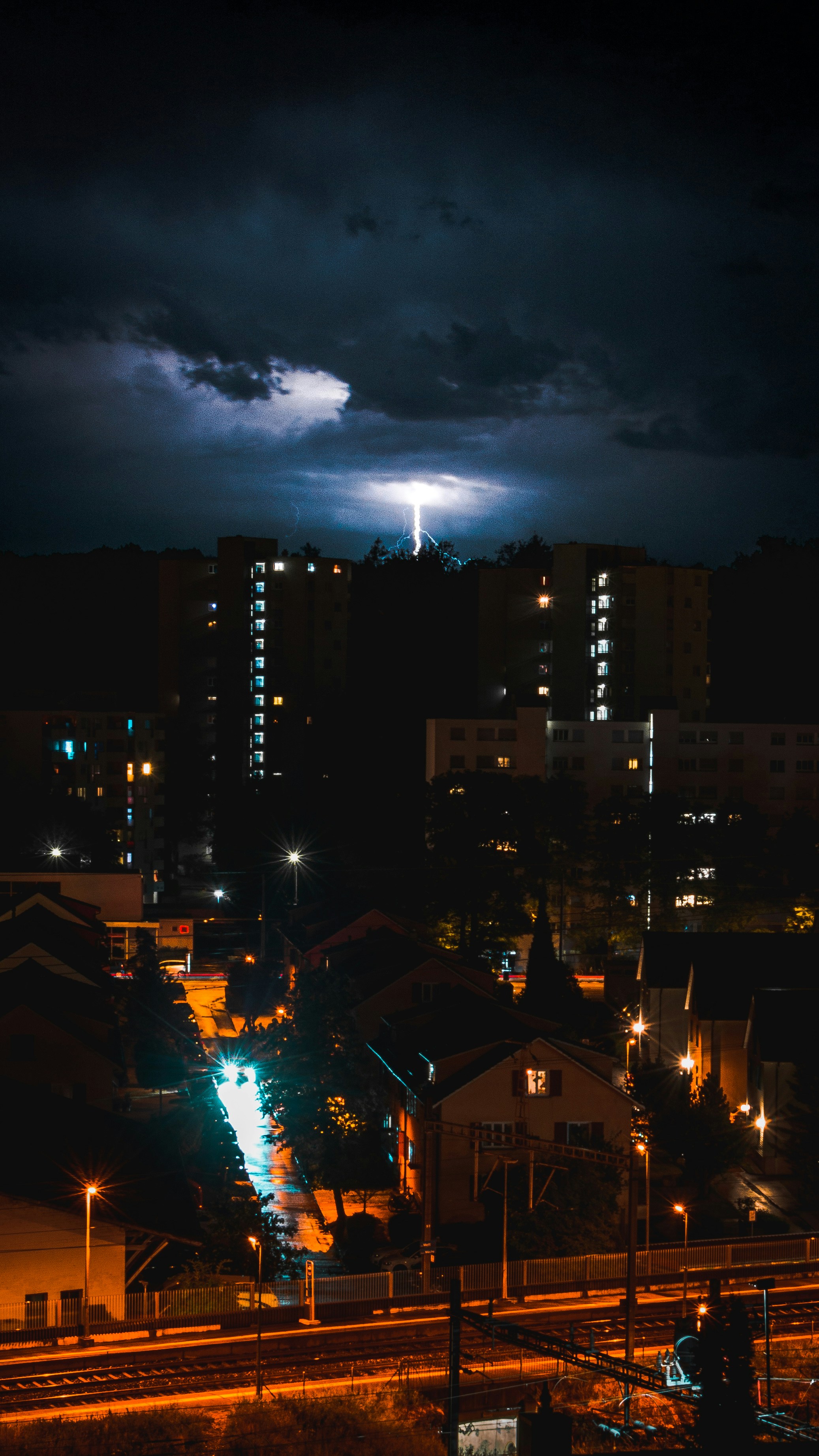 Lightning at the Edge of Night Over a Suburban Skyline