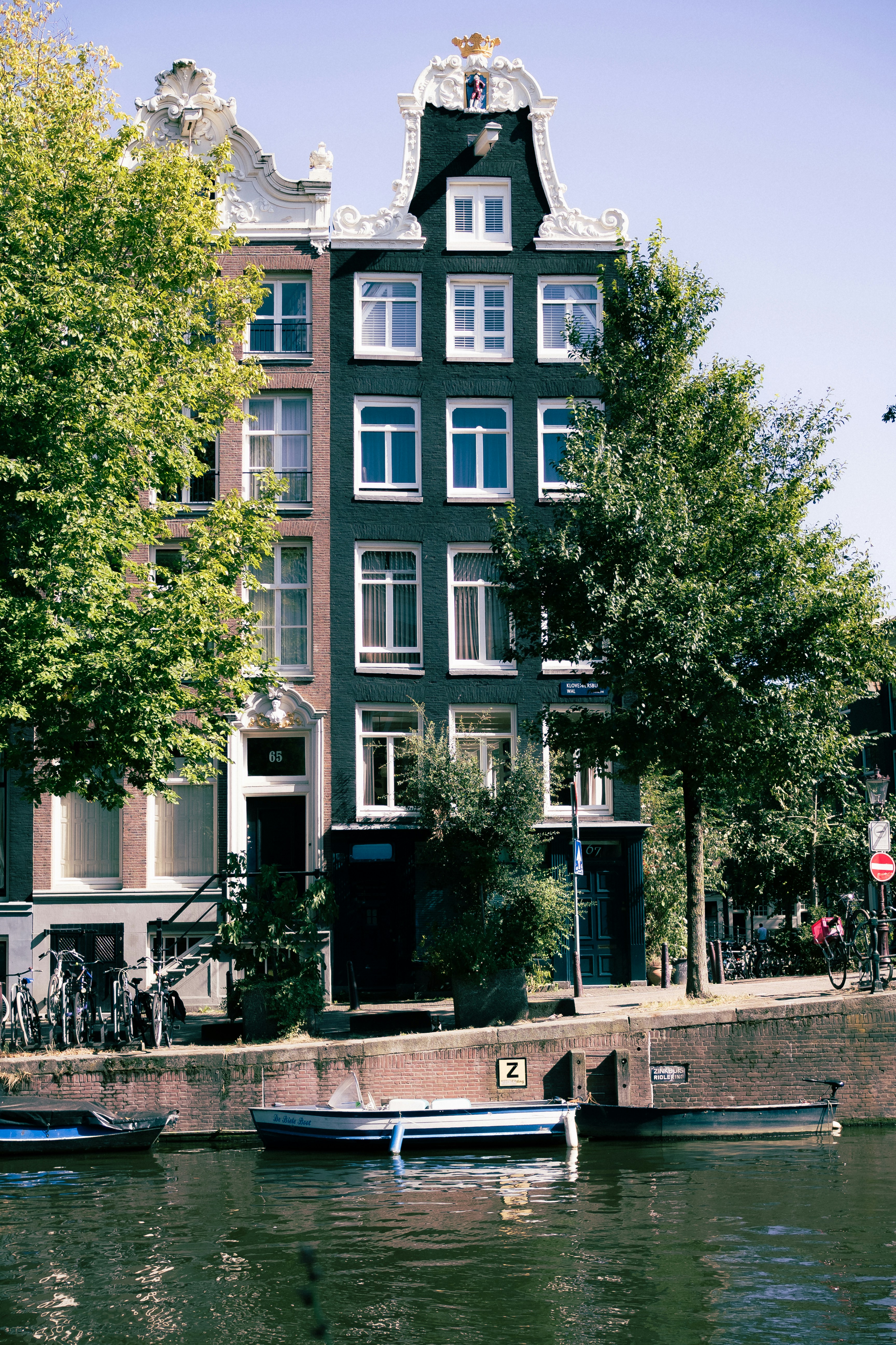Verdant Canal House Framed by Trees, Boats and Bicycles