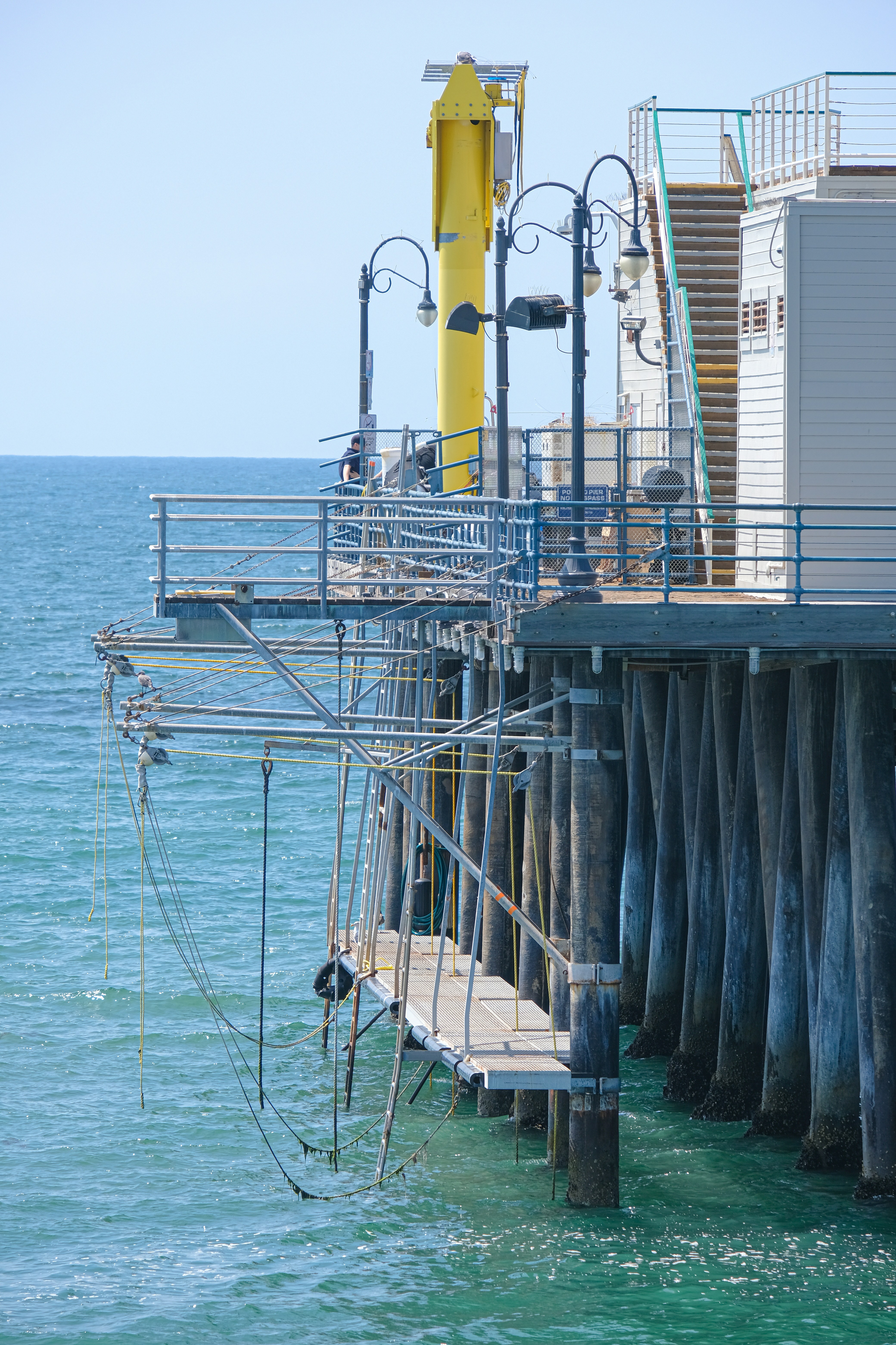 A pier with a yellow buoy on top of it photo – Free Ca Image on Unsplash