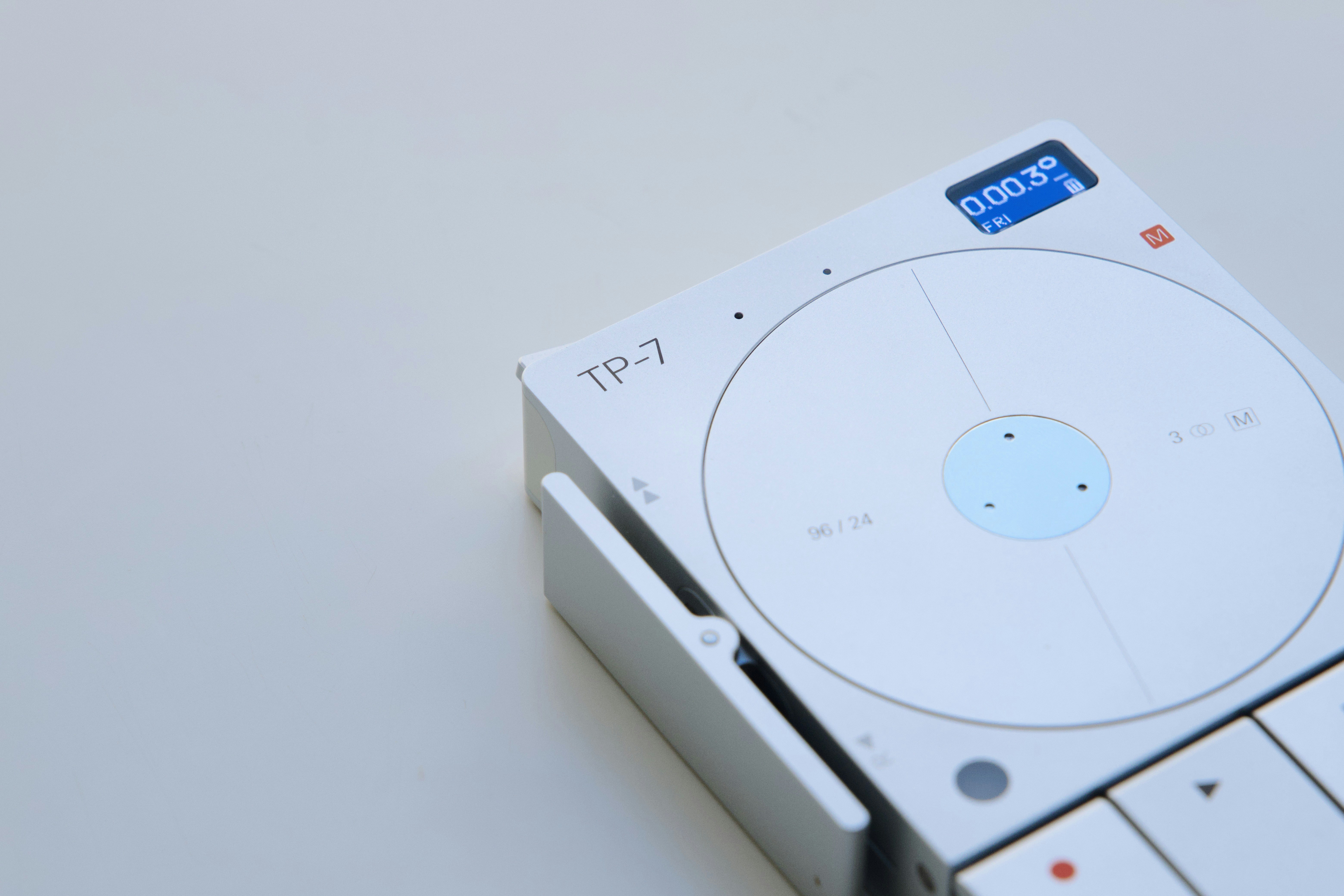 A white cd player sitting on top of a table photo – Free Journalist ...