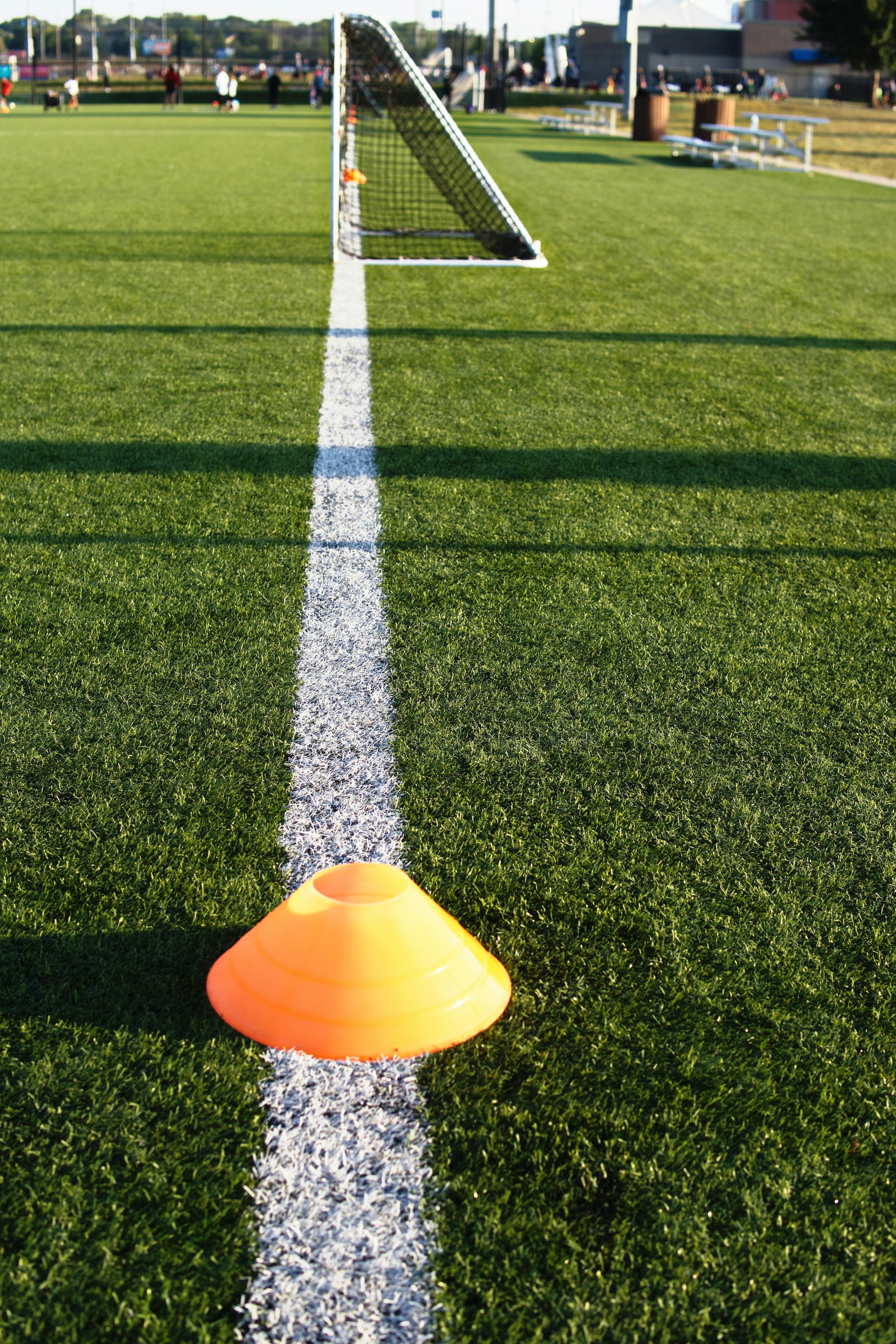 A yellow frisbee sitting on top of a soccer field photo – Free Soccer ...