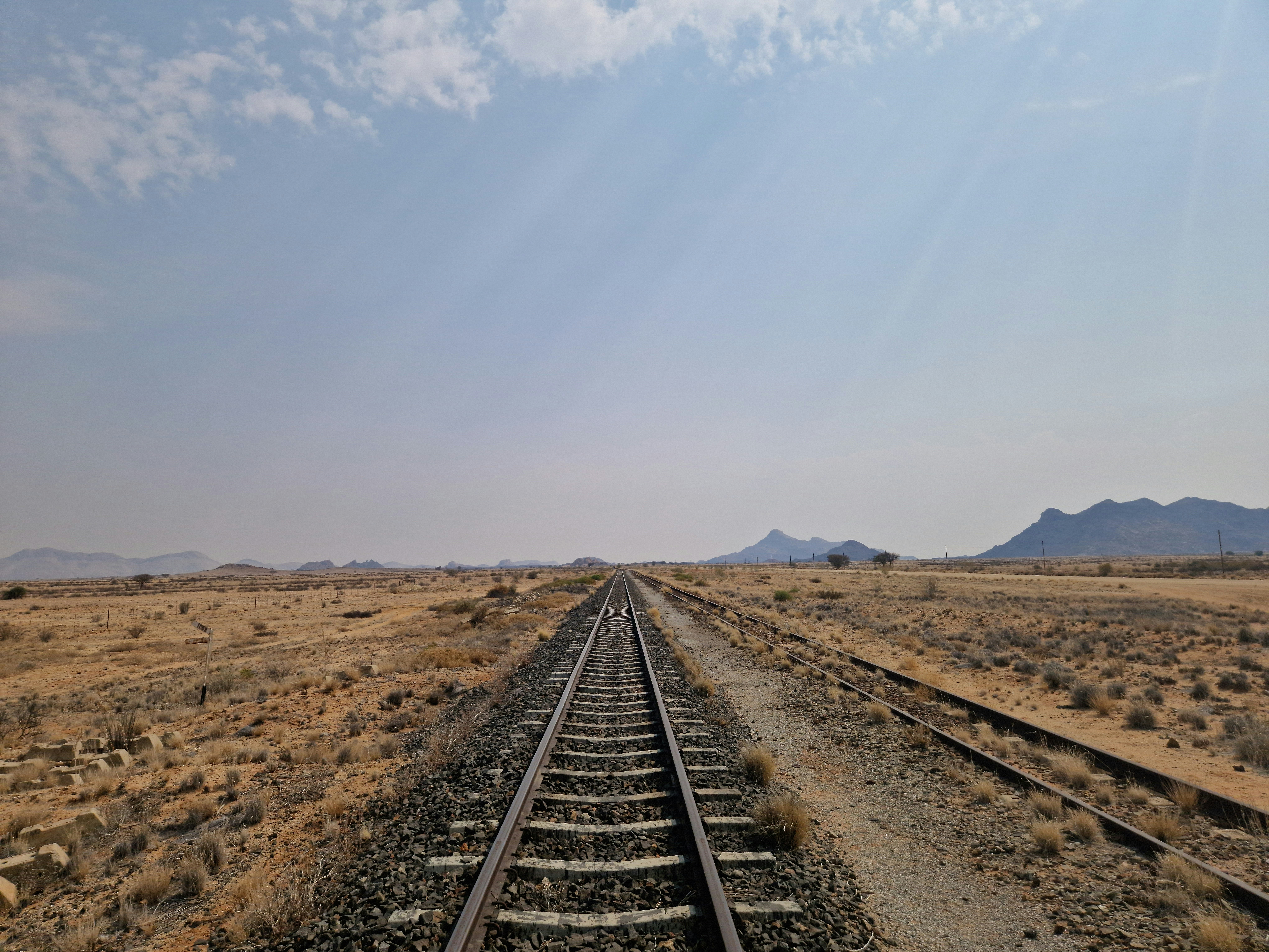 A train track in the middle of a desert photo – Free Desert Image on ...