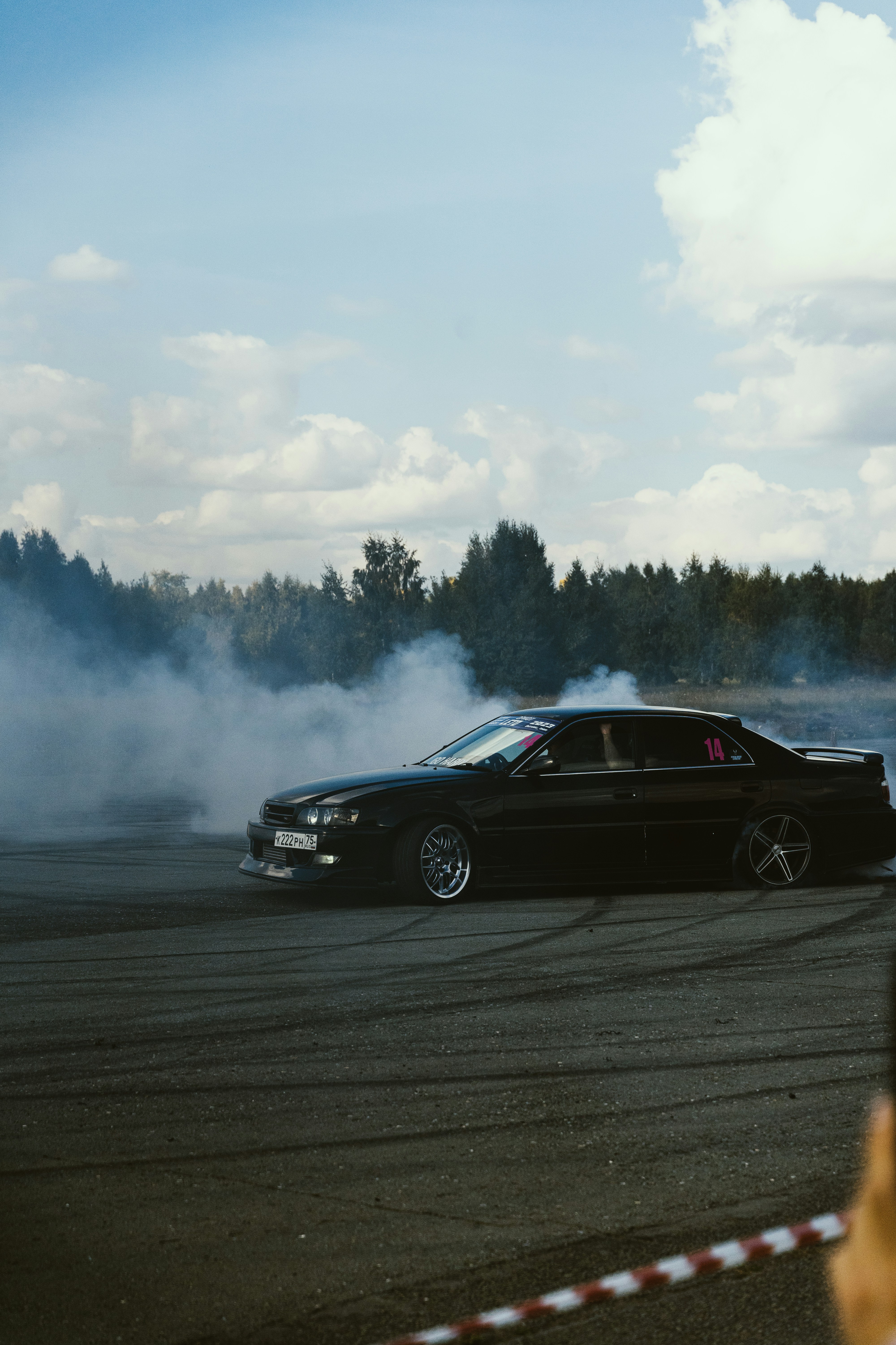 a car that is on a track with smoke coming out of it