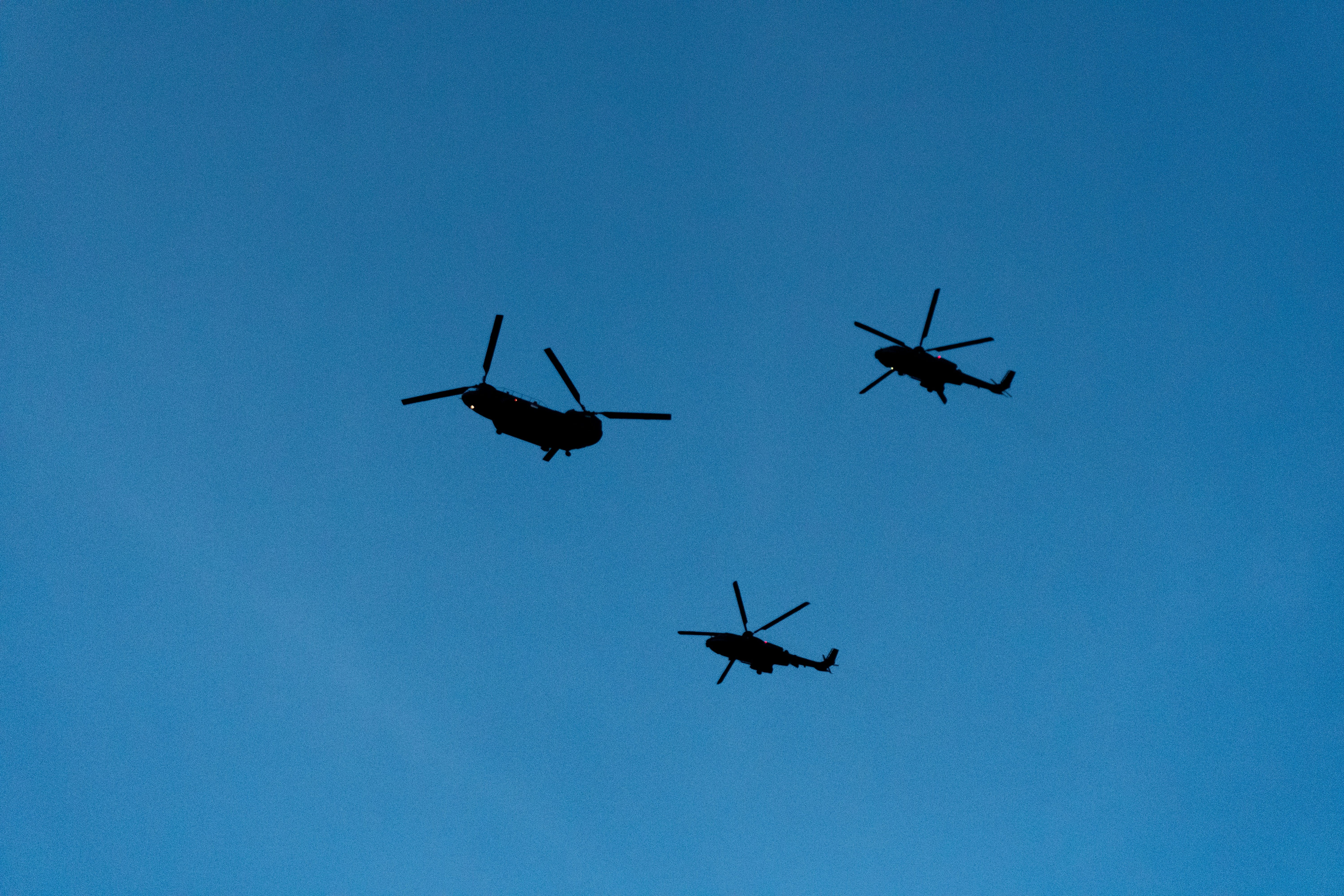 Three military helicopters flying through a blue sky photo – Free ...