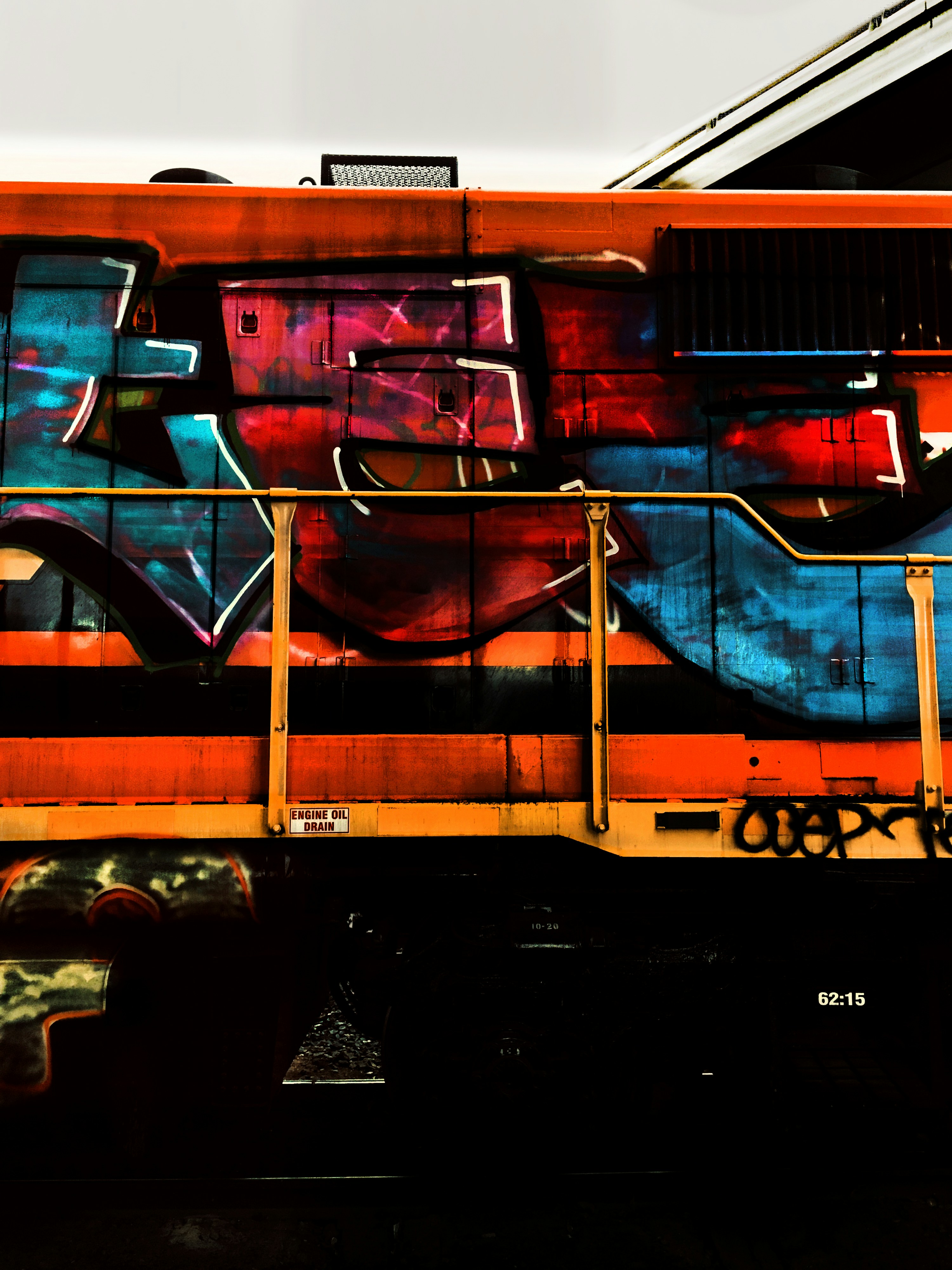 VANE TRAIN - an orange locomotive resting alone on the tracks in the industrial area of Fresno, CA. LARGE | BOLD | COLORFUL lettering gifted from an artist i will never see. my challenge was traversing the 200', climbing thru two fences & hopping an additional fence with no rips/tears in my attire. this outing was good session! cloud cover was a soft box creating idyllic lighting. abstractdigitalsim | e.powell | 2k22 | TRAINS
