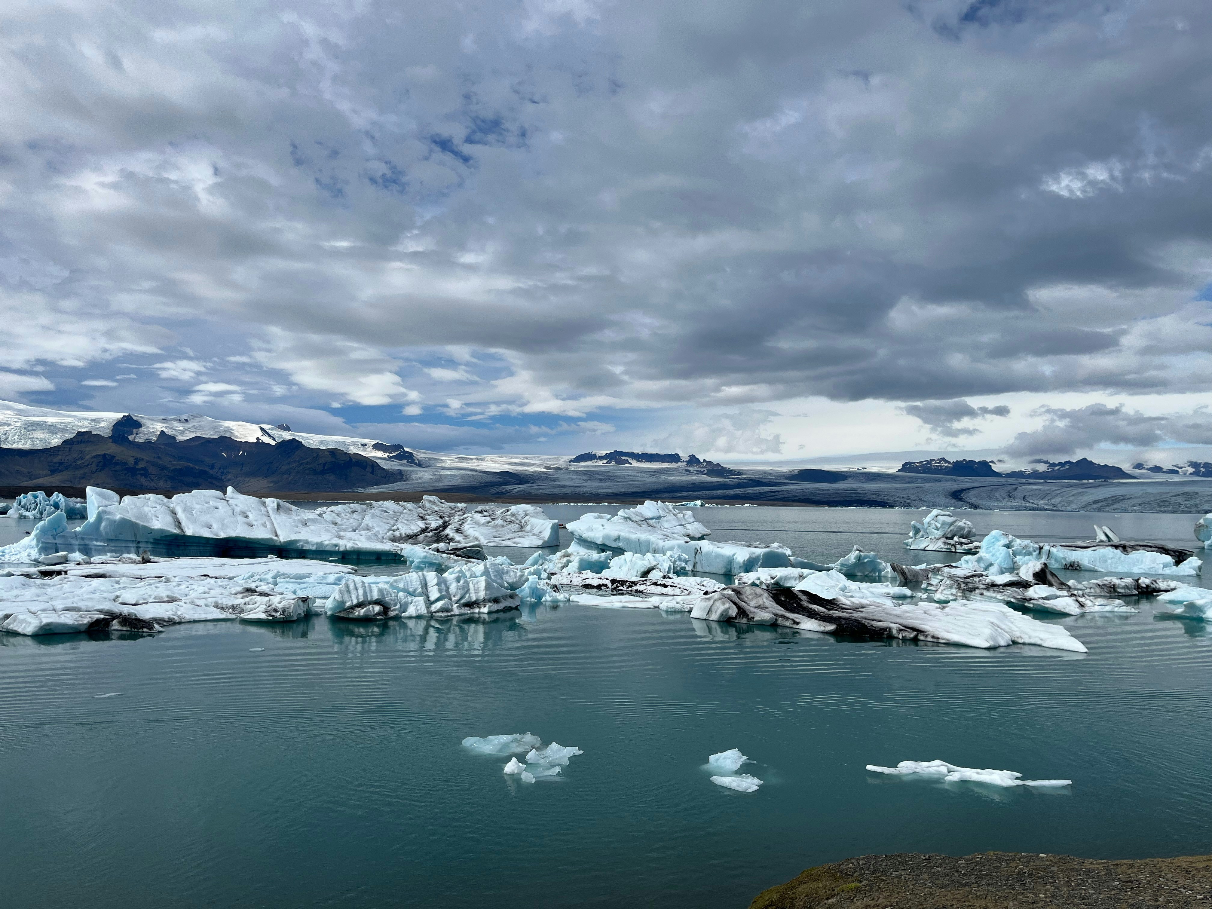 a group of icebergs floating on top of a body of water