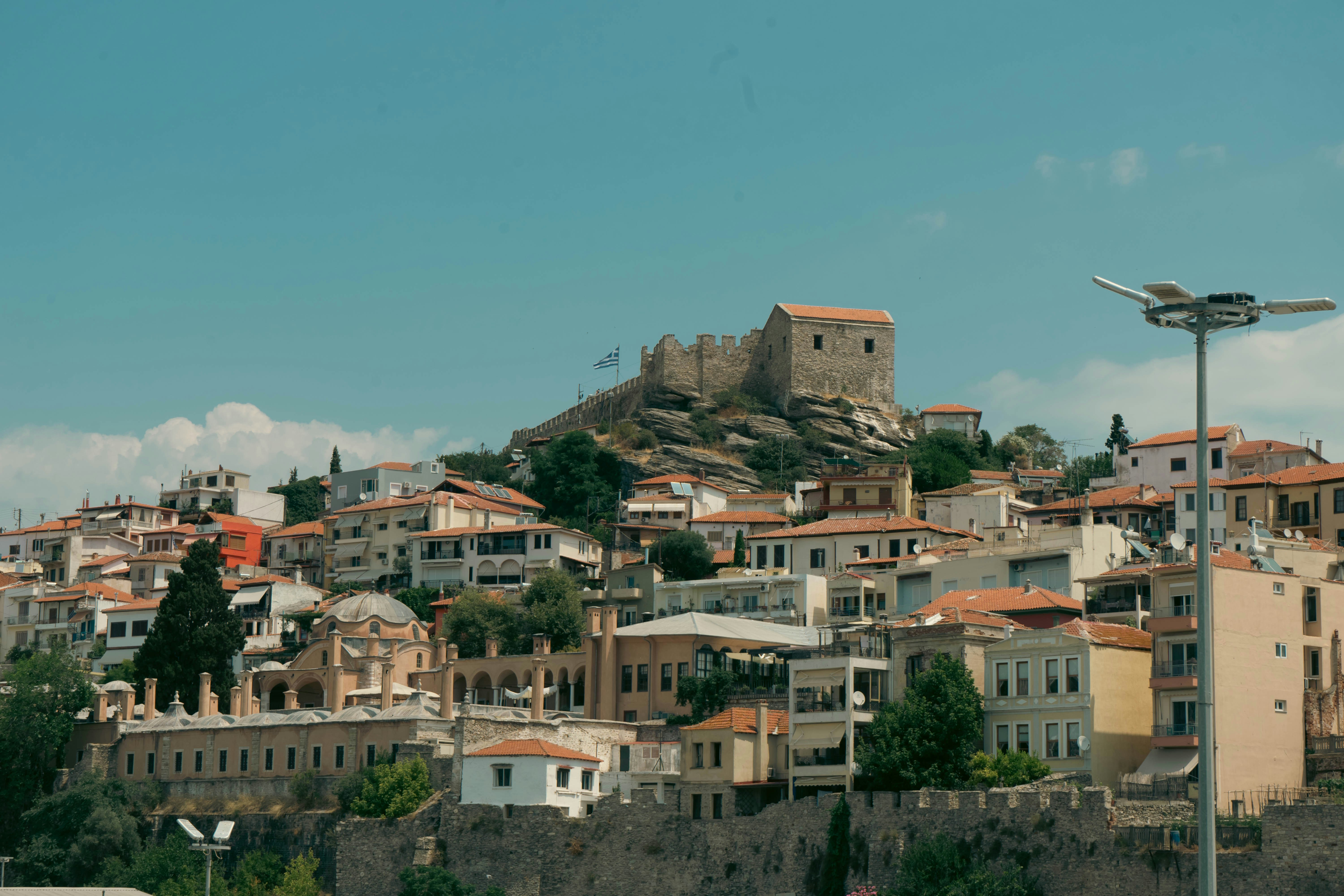 A view of a city with a castle on top of it photo – Free Greece Image ...