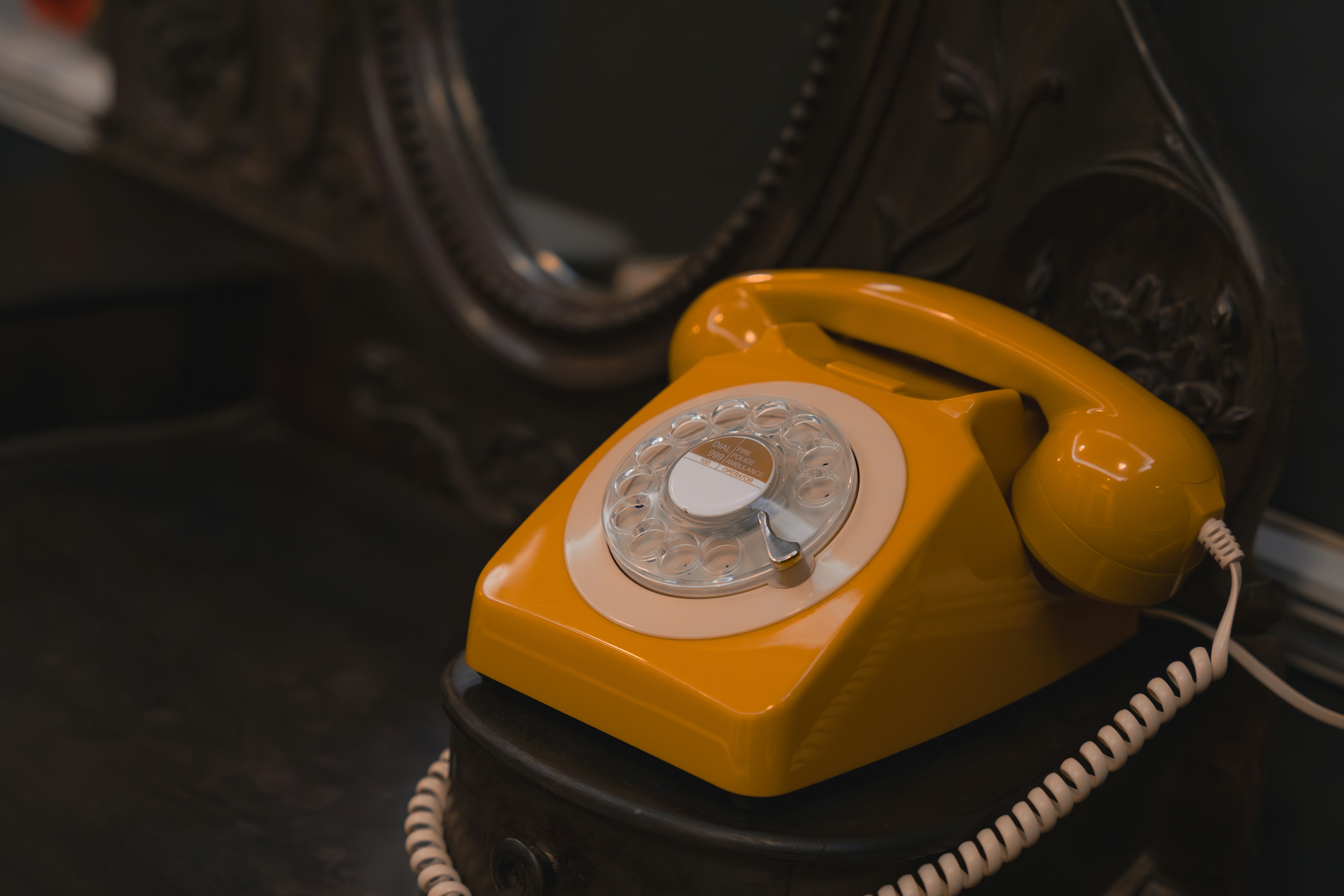 A yellow telephone sitting on top of a table photo – Free Electronics ...