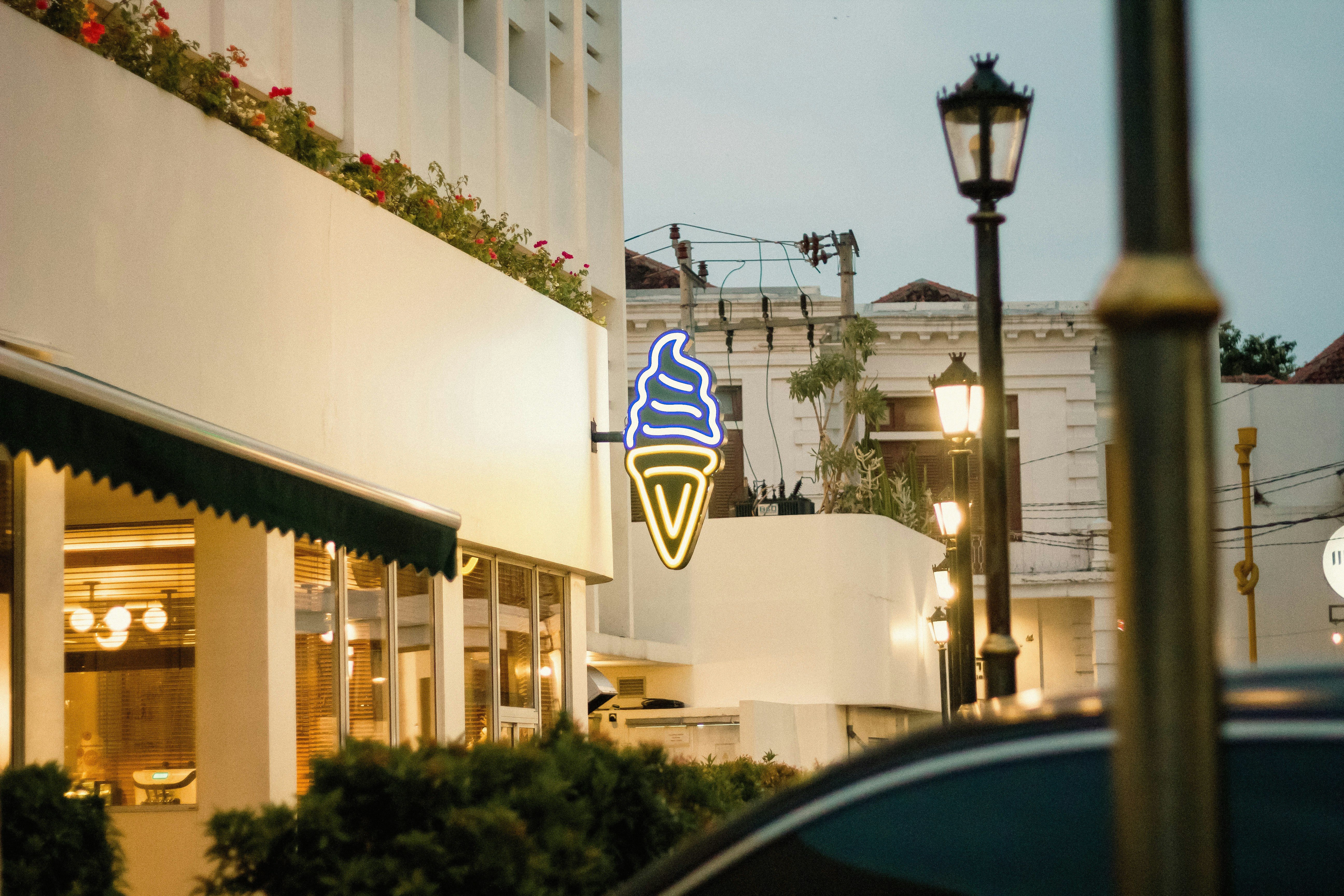 Neon Ice Cream Sign Illuminates a Quiet Street Corner