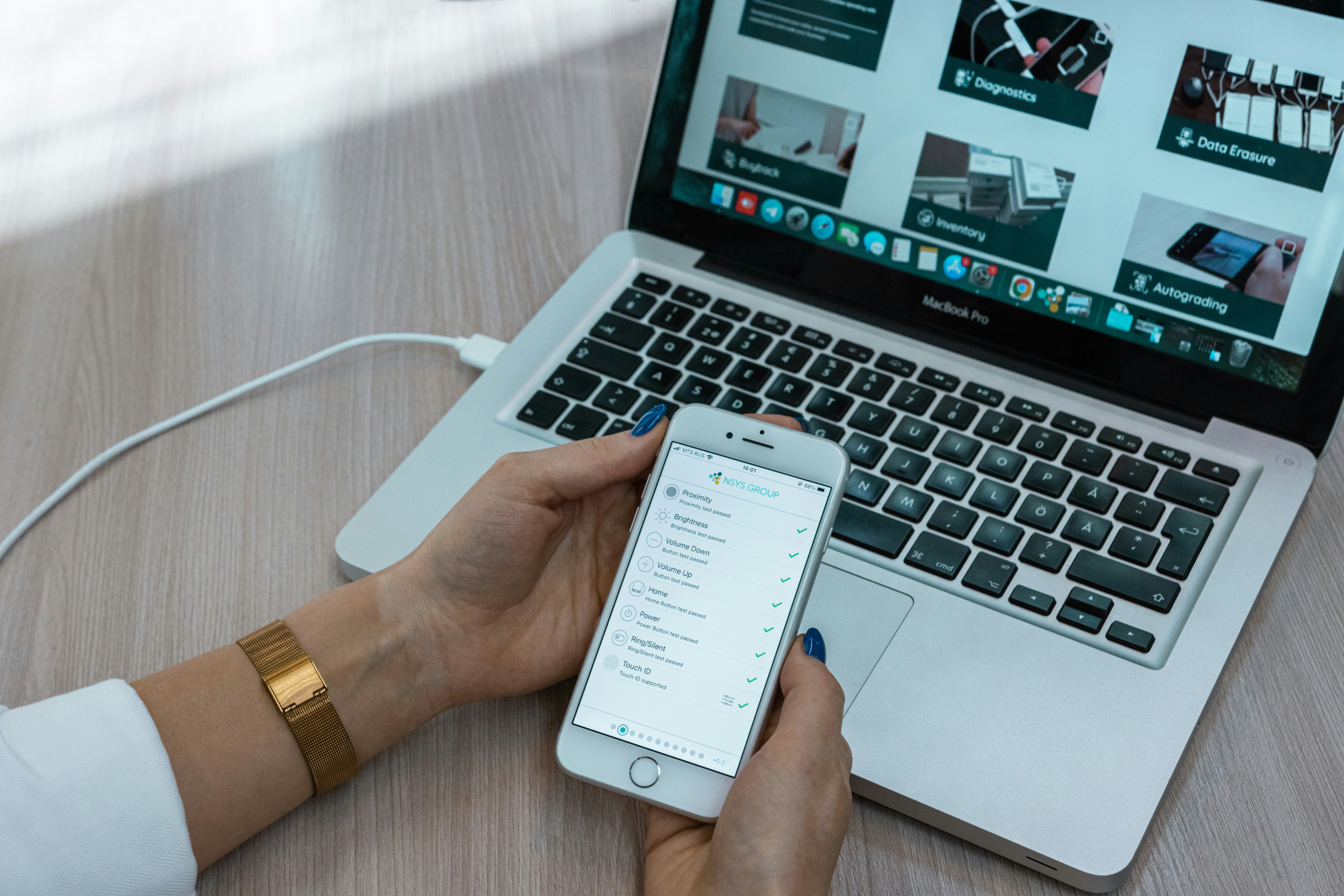 A person using a cell phone and laptop on a table photo – Free Computer ...