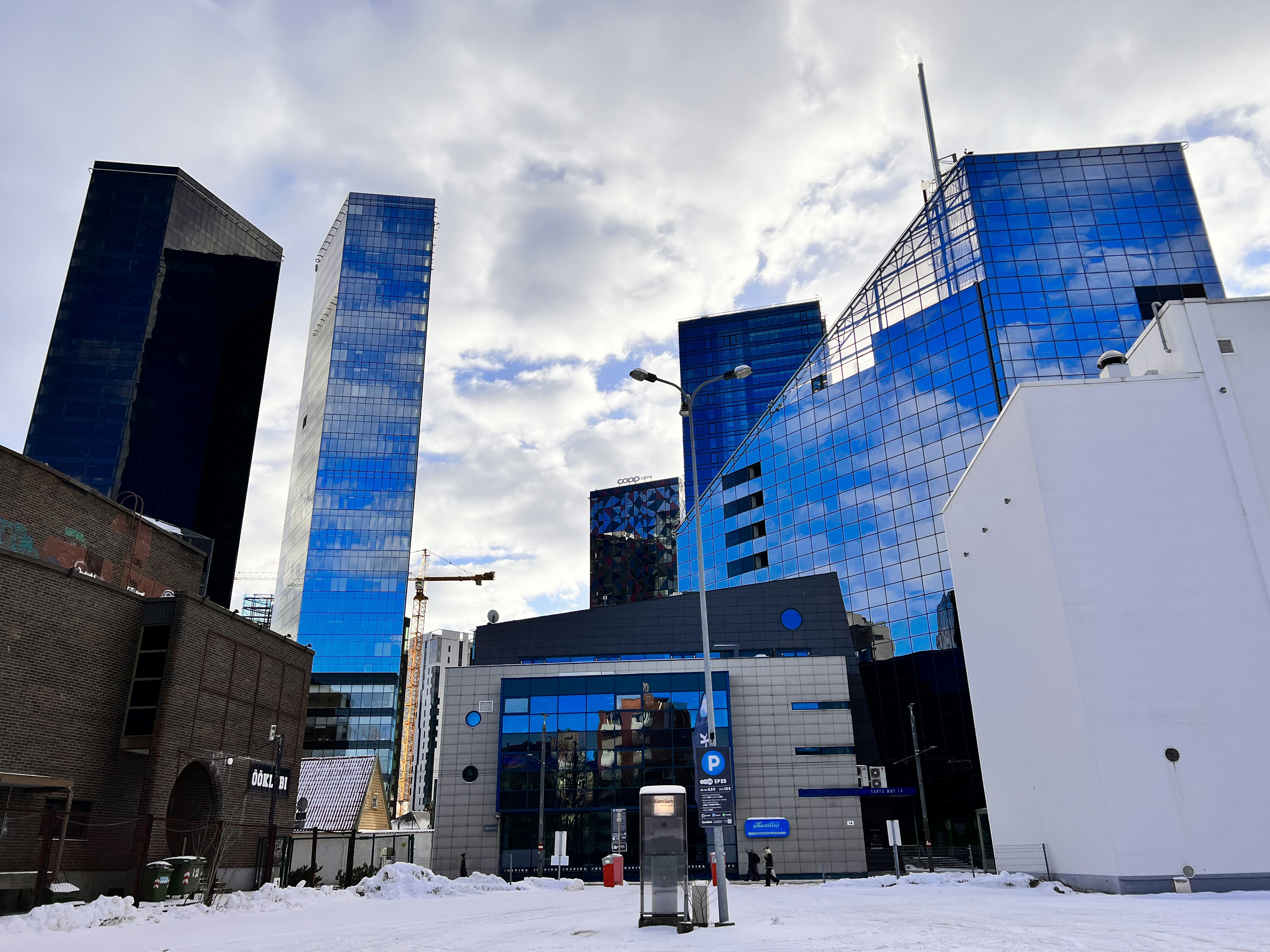 Ice-Blue Towers Reflect Winter Sky Over Snow-Covered Plaza