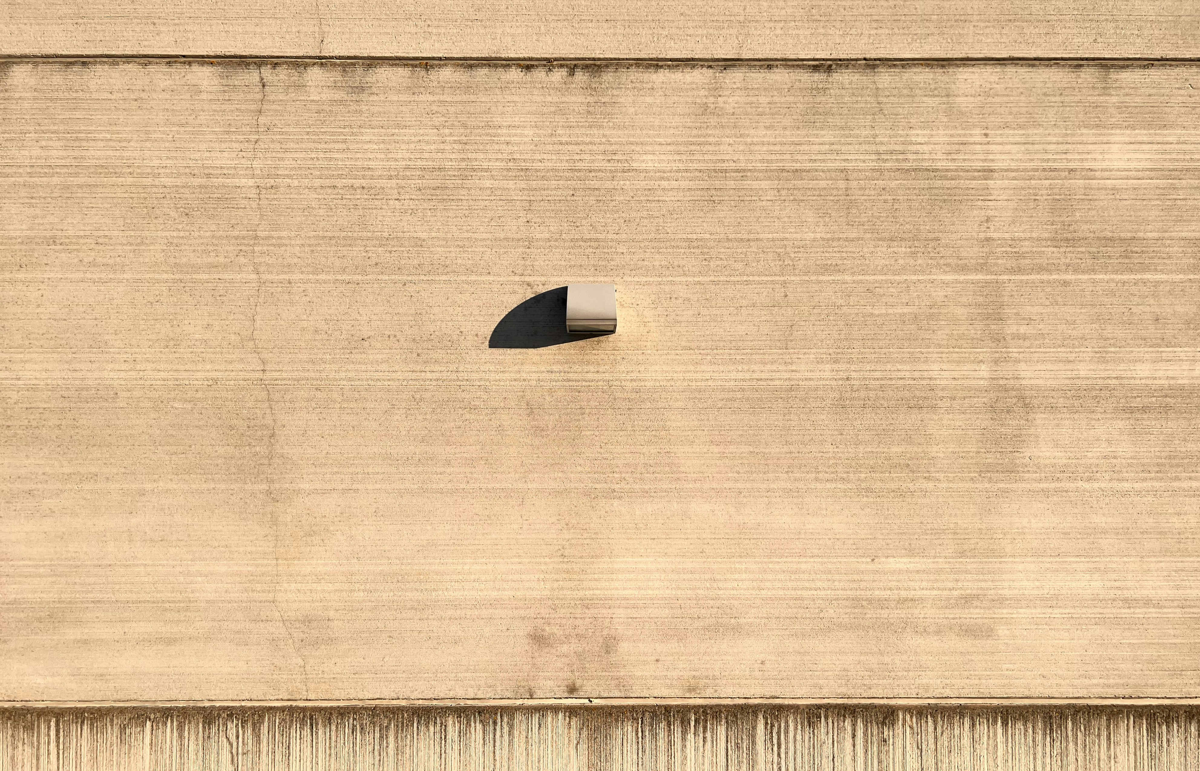 Crescent Cutout on Sunlit Concrete