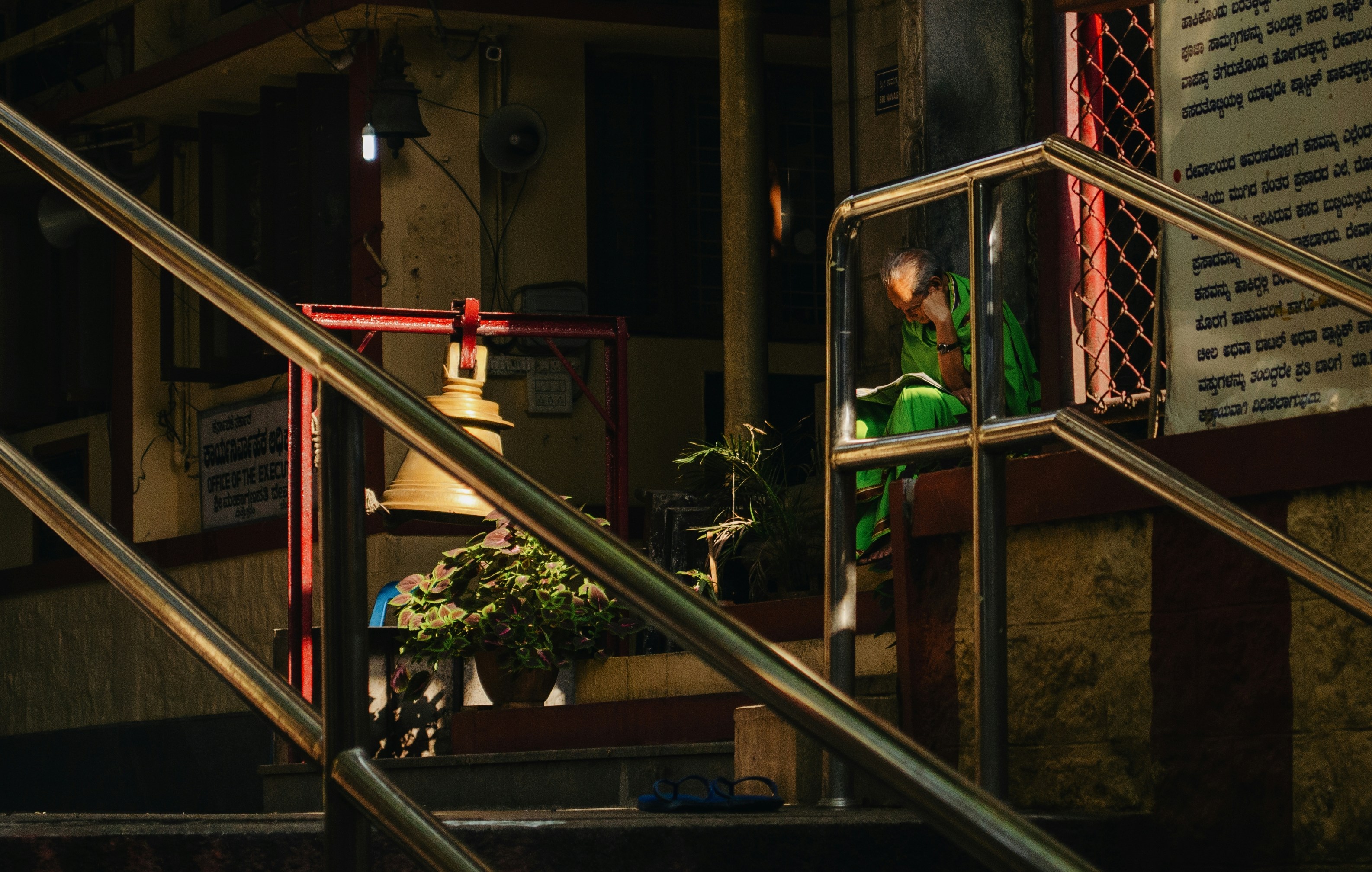 Green in the Night: A Quiet Pause Behind Staircase Rails