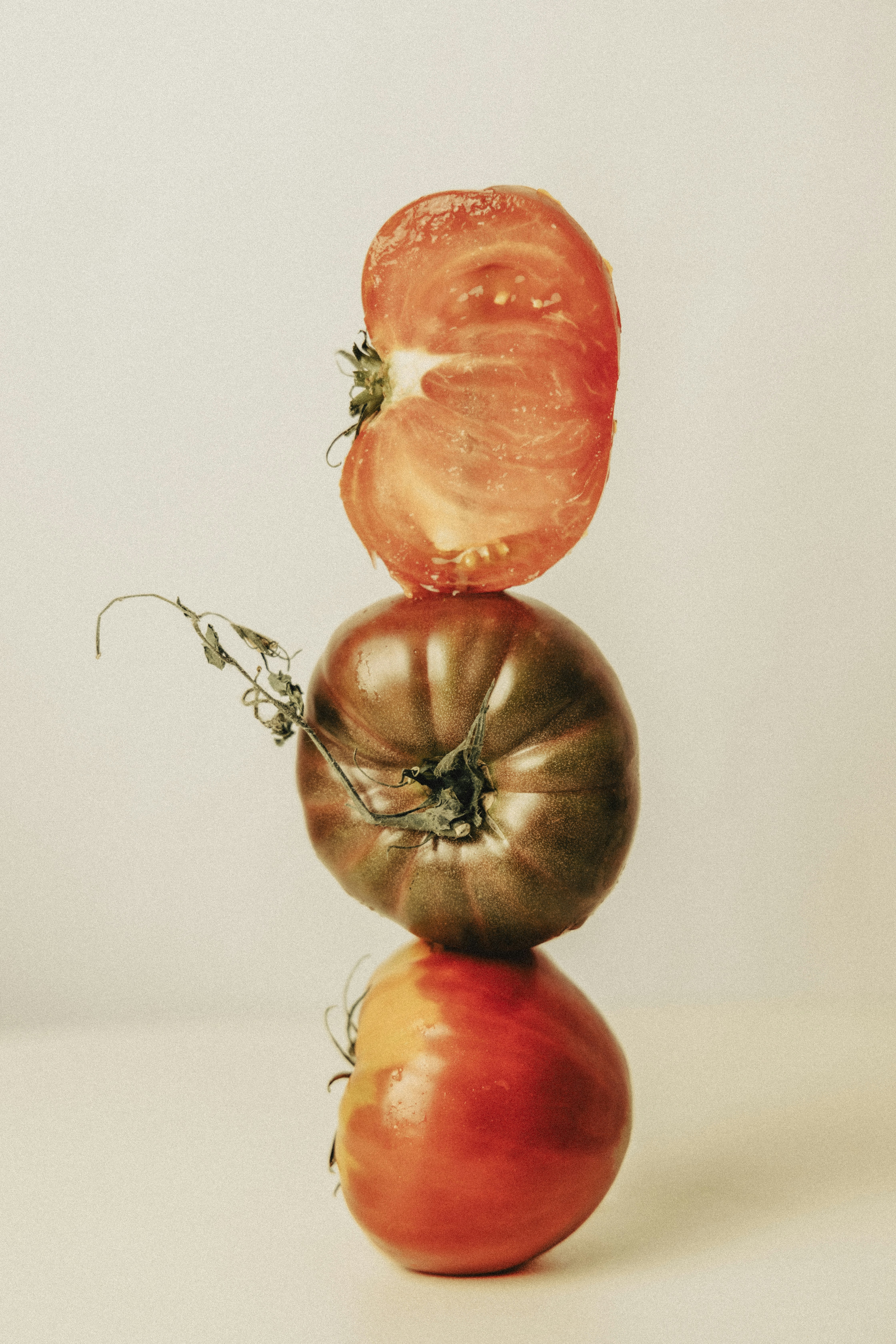 Stacked in Silence: A Vintage-tinged Still-Life of Three Tomatoes