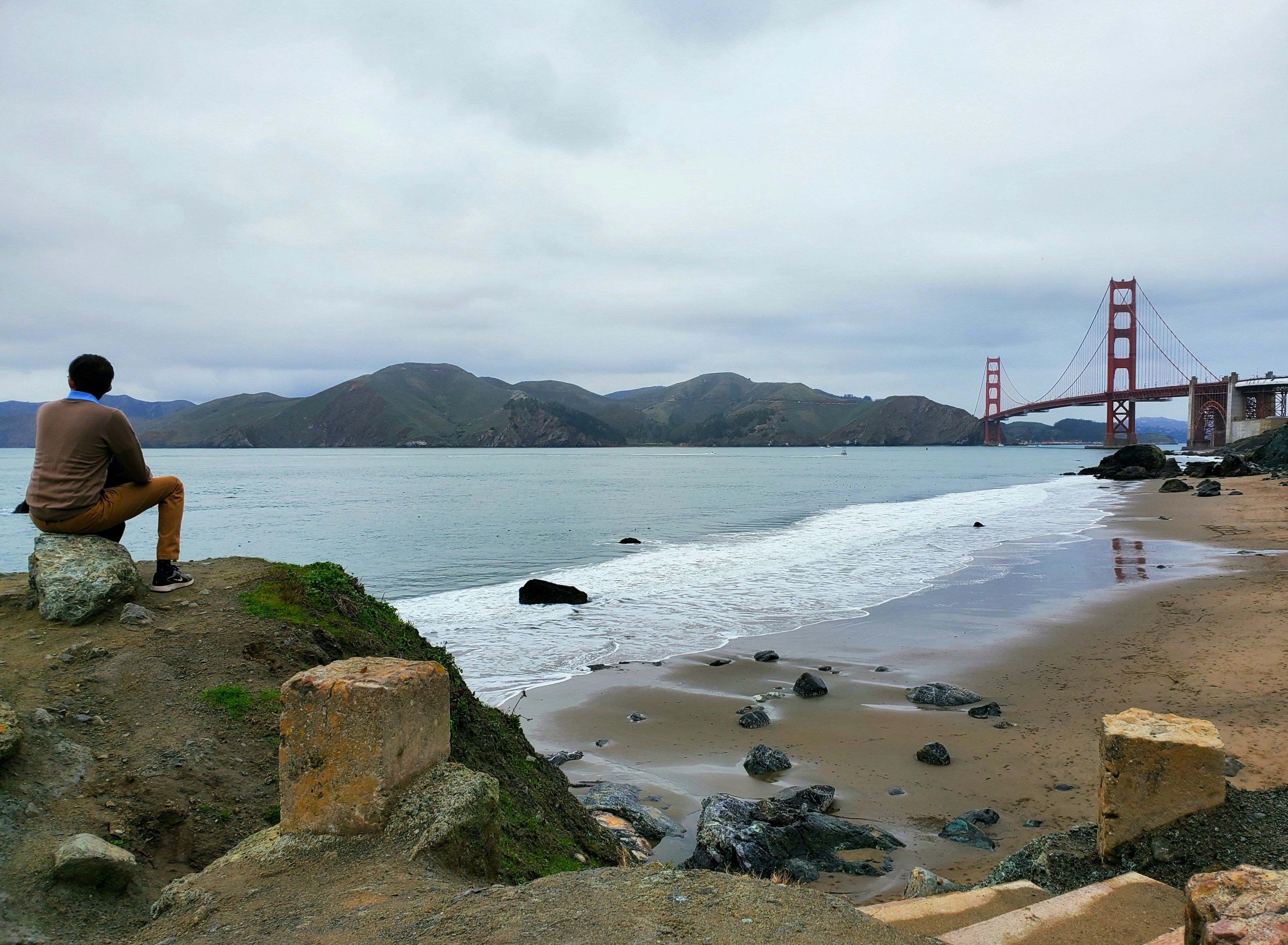 Lone Observer by the Bayfront: The Golden Gate Narrowly Framed in Overcast Light