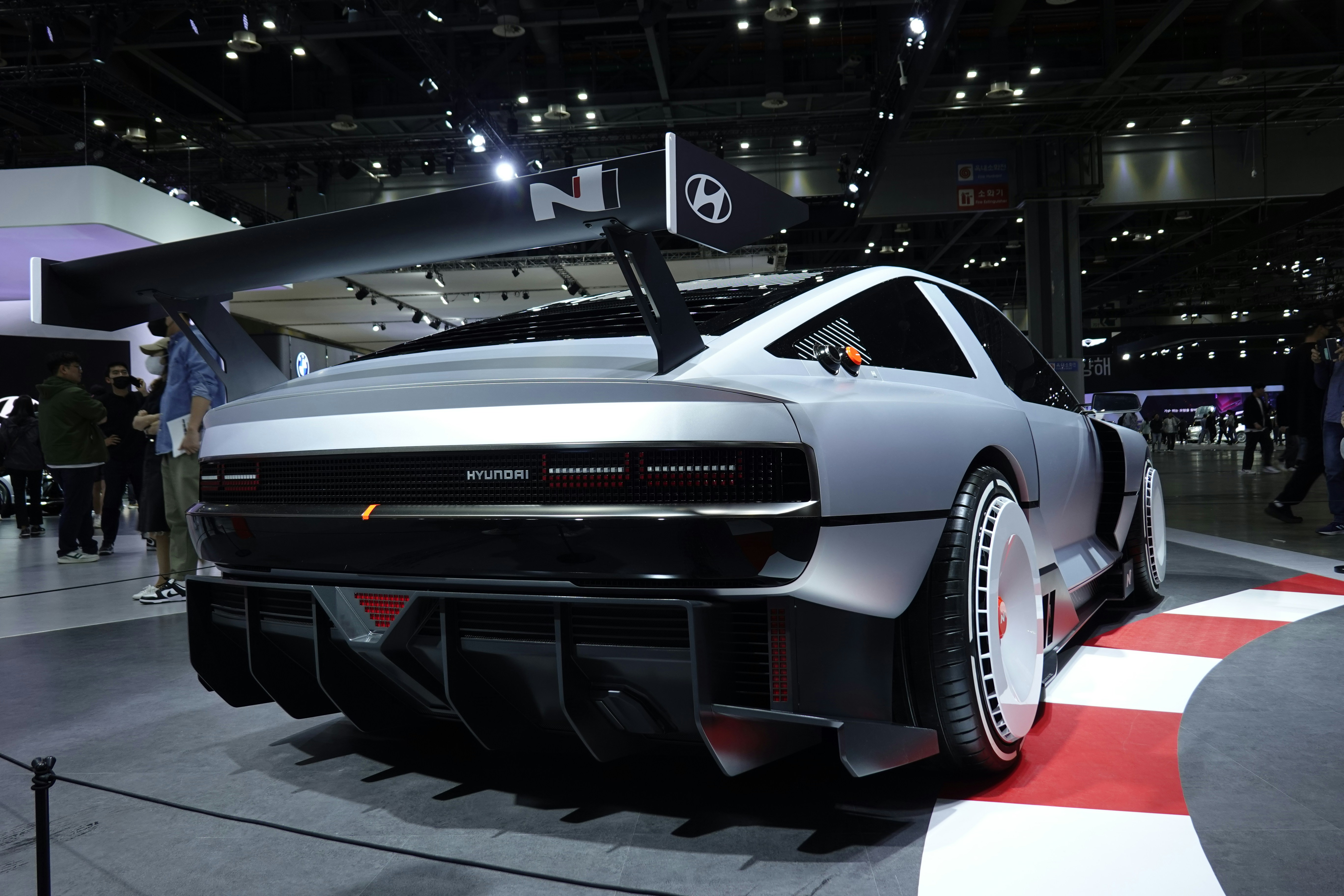 A silver sports car on display at a car show photo – Free Car Image on ...