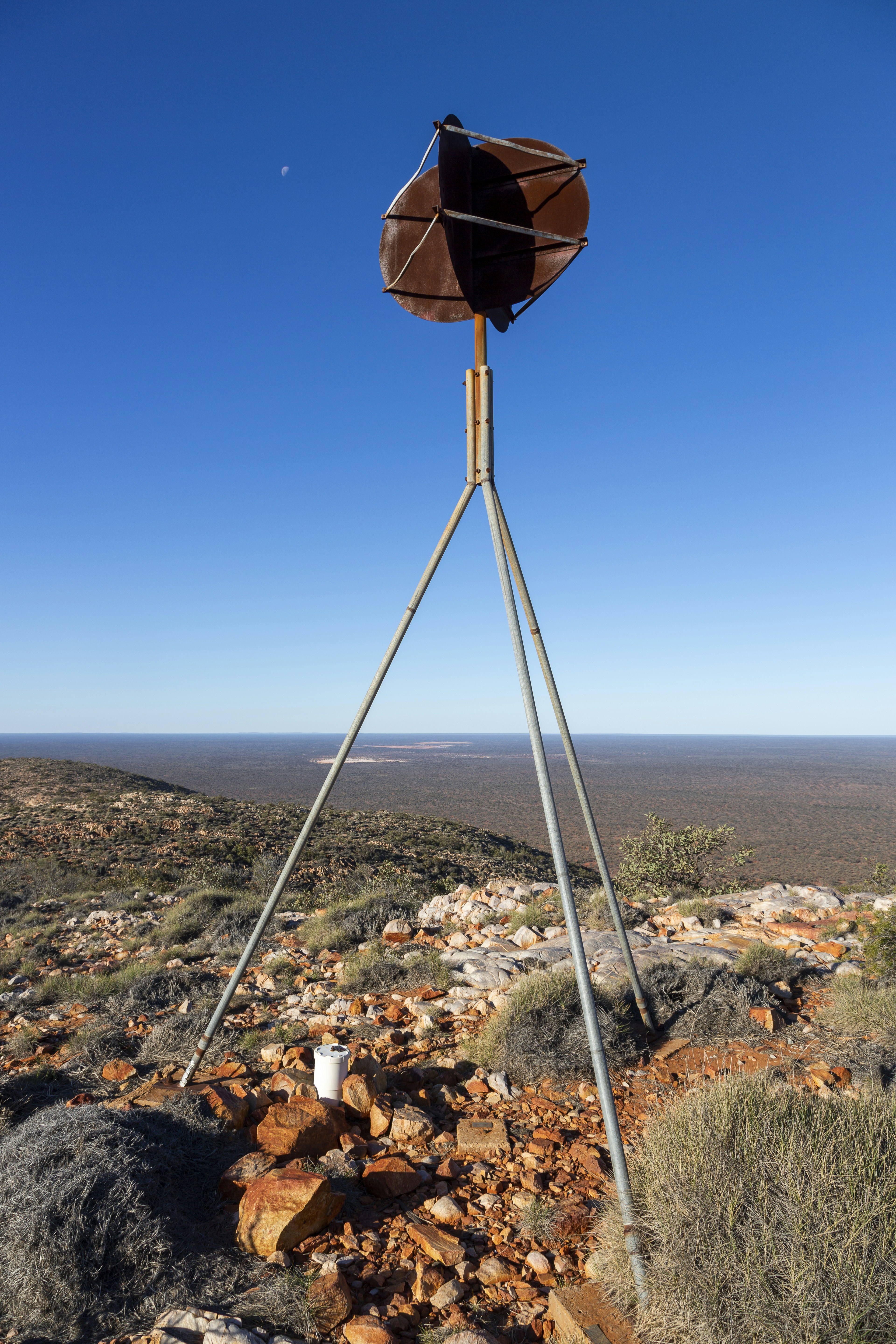 Desert Sentinel: A Tripod-Mounted Dish Reaching Toward the Vast Blue Sky