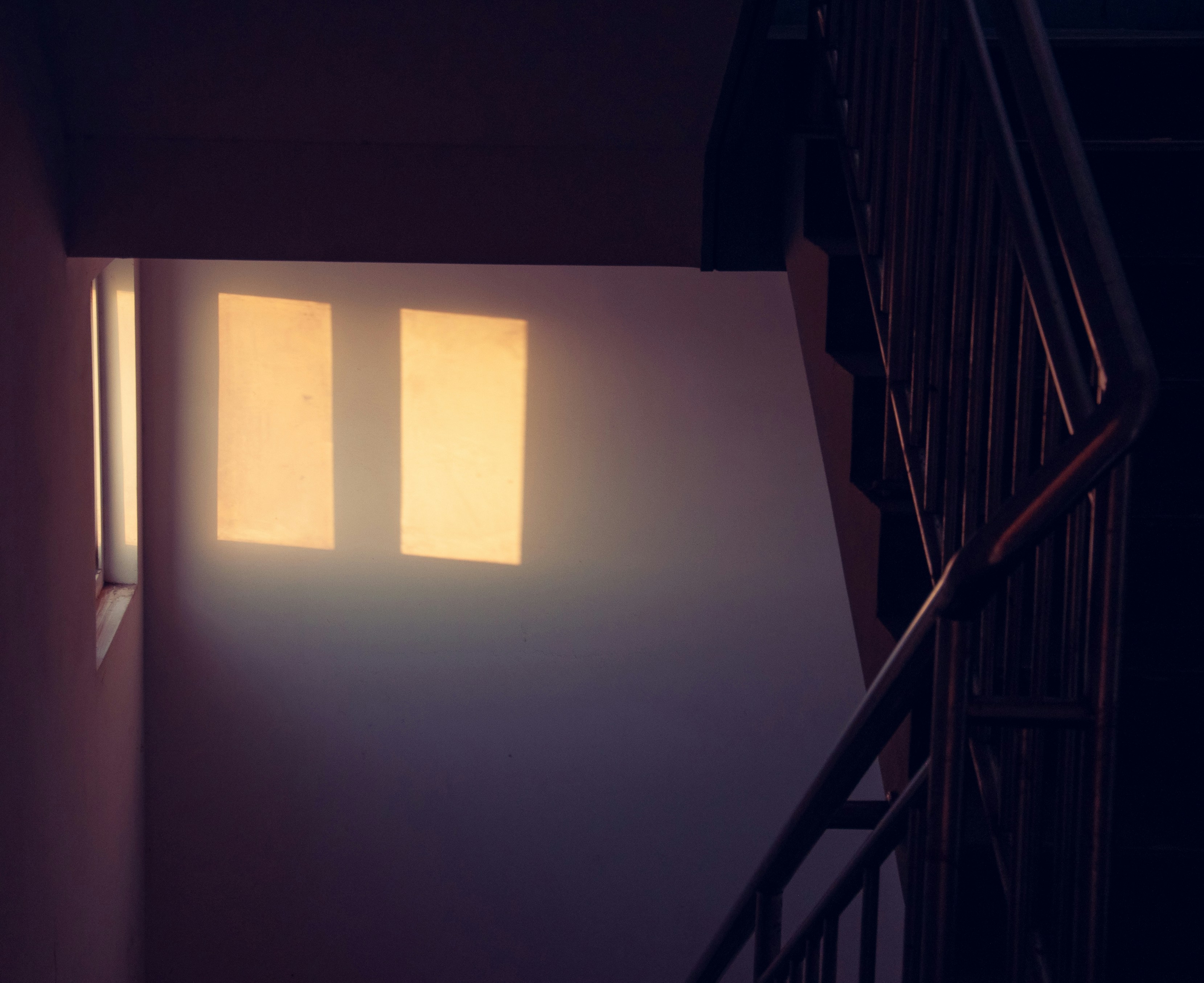 A stair case with a light coming through the window photo – Free Image ...