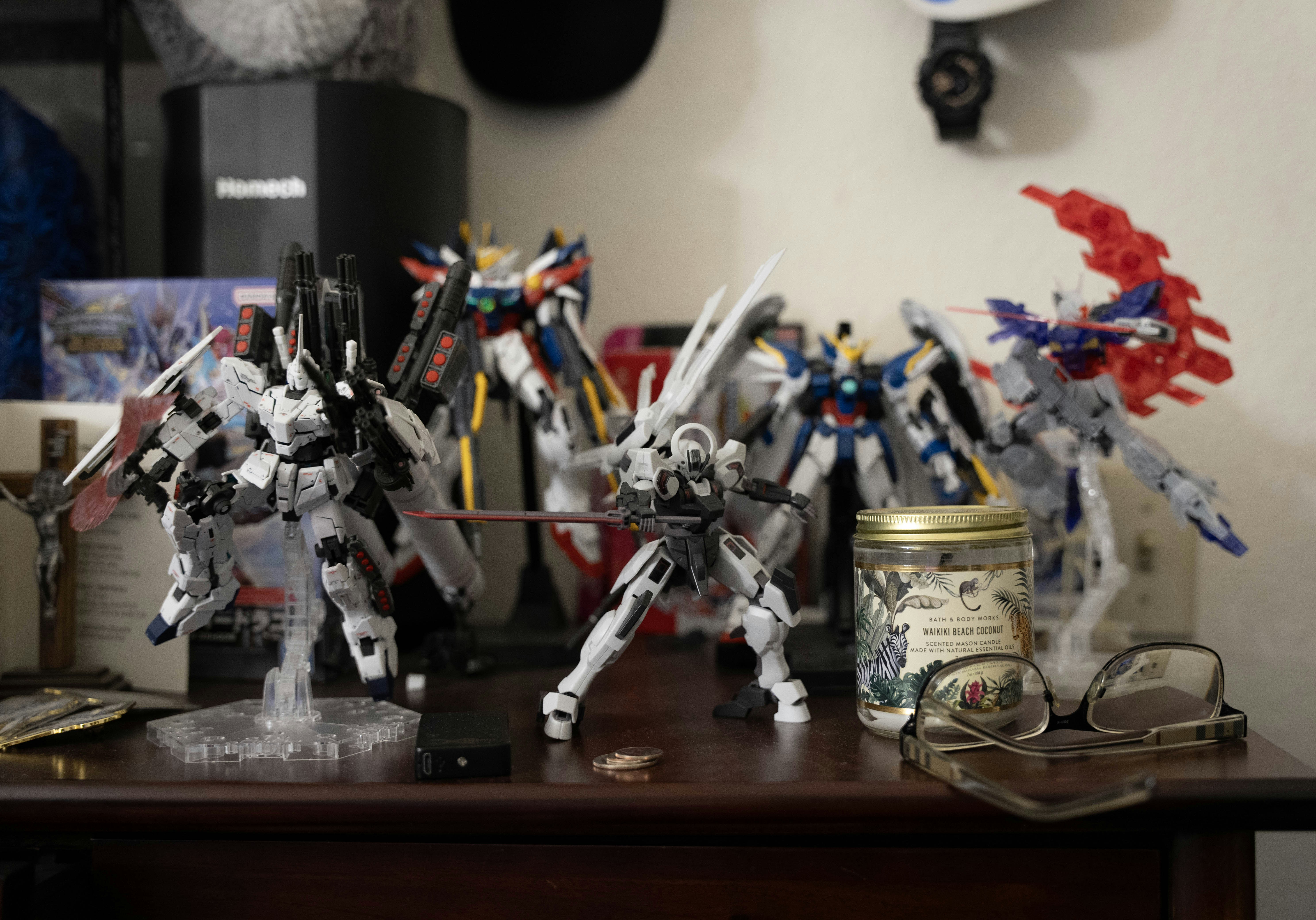 A table topped with toy figurines and a jar of paint photo – Free ...