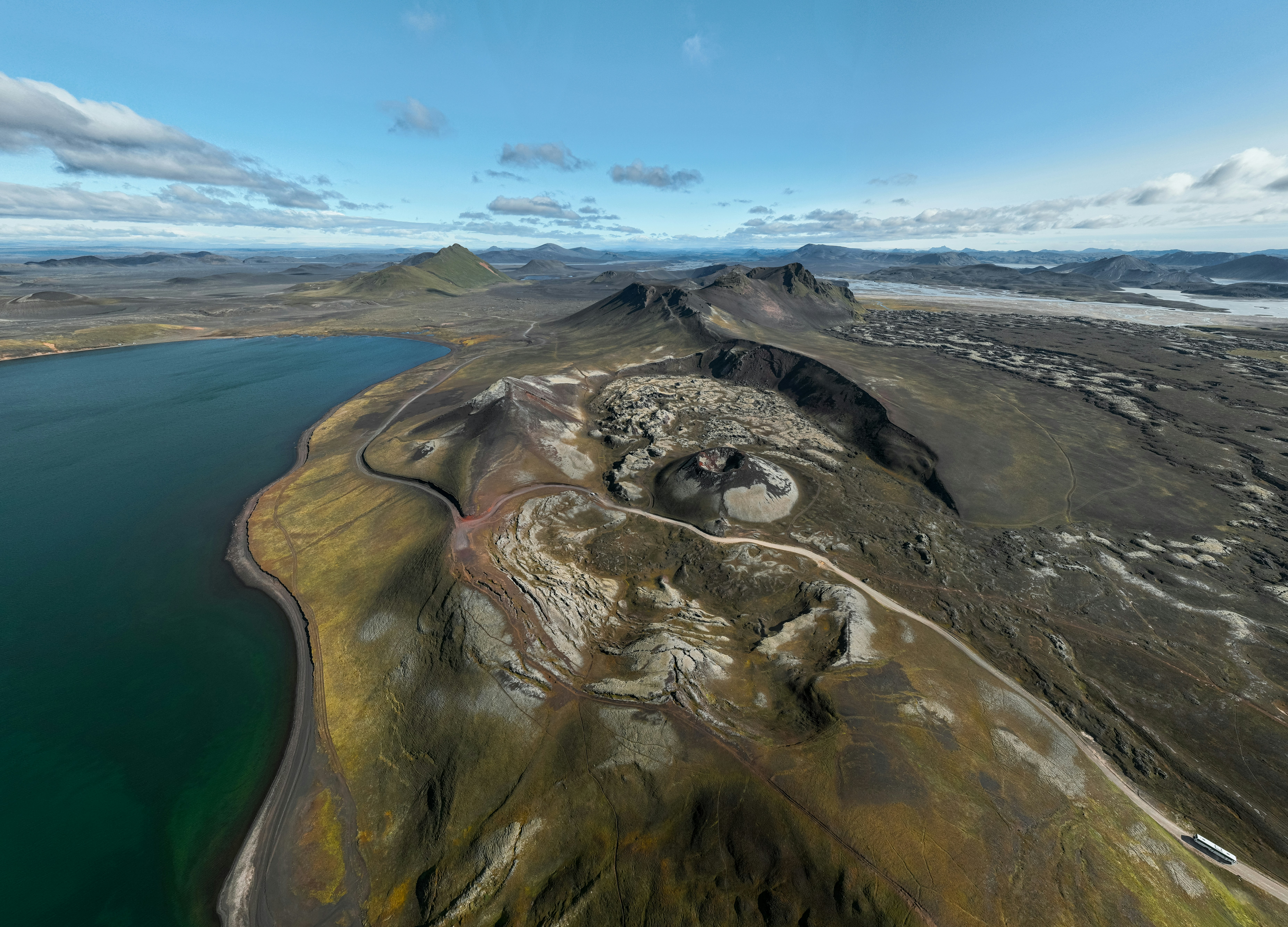 Caldera Crest: Lava-Textured Ridge Along a Serene Shore