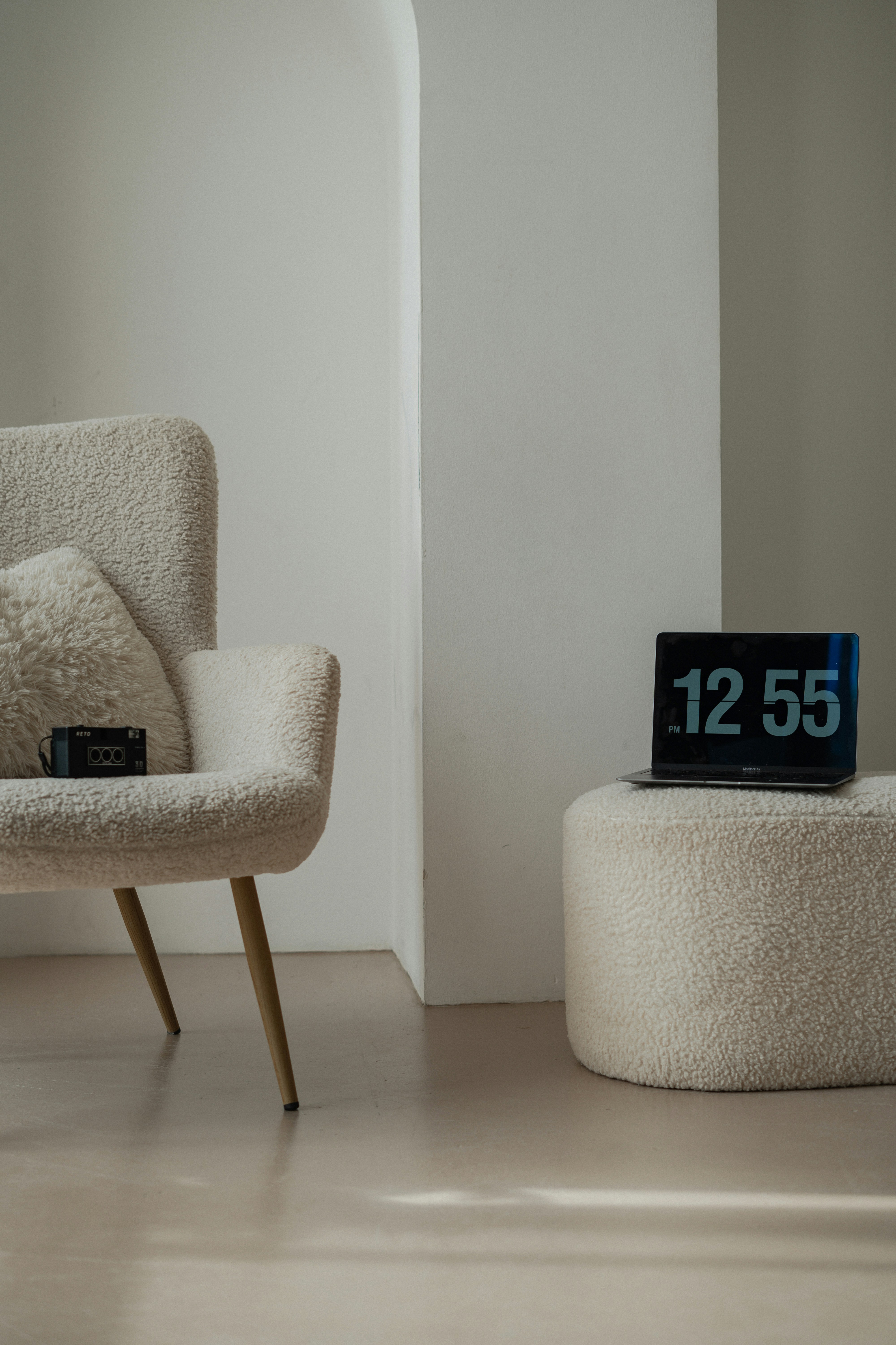 Clocked Calm: Minimal Cream Studio with a Digital Time Display