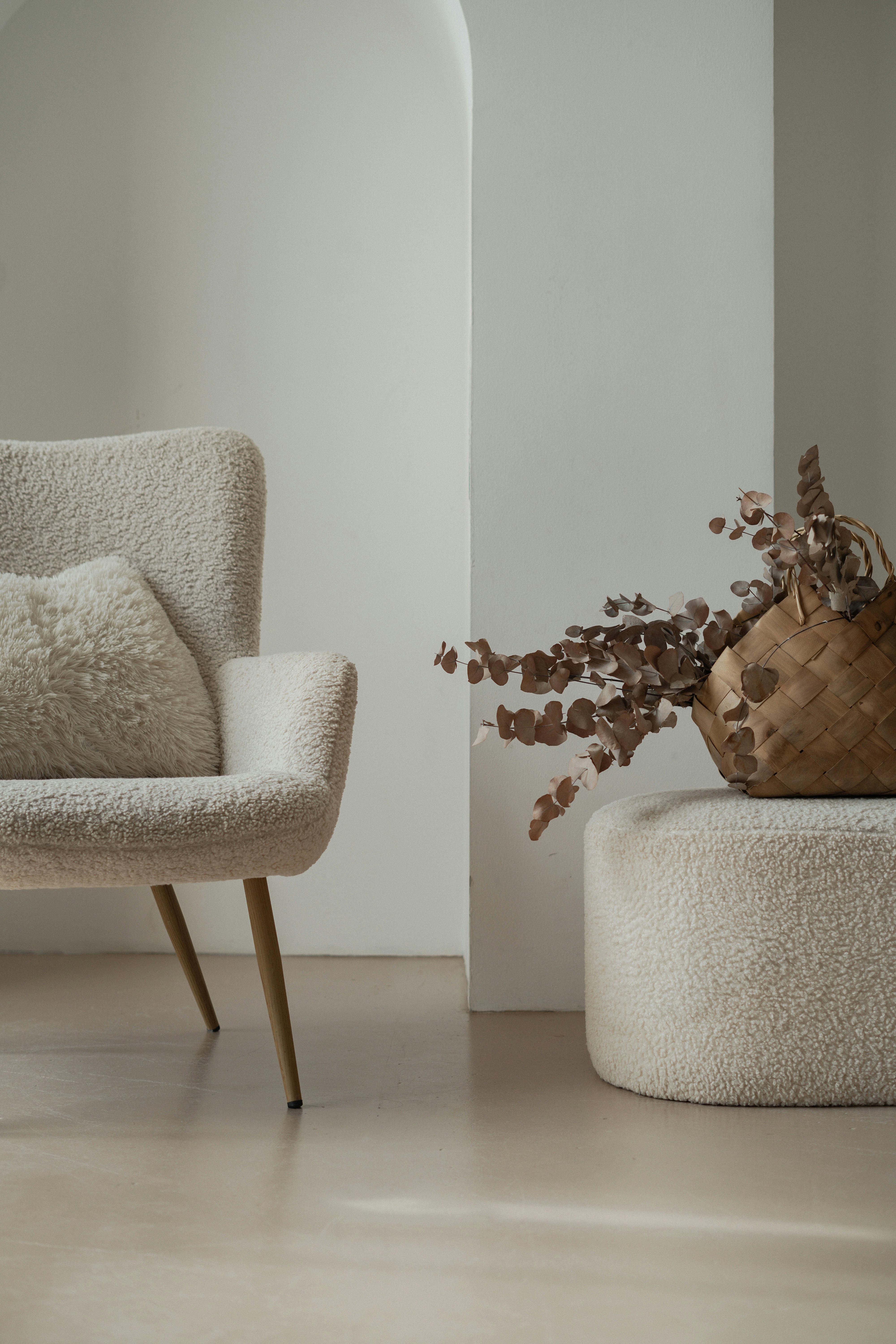A chair and a foot stool in a room photo – Free Furniture Image on Unsplash