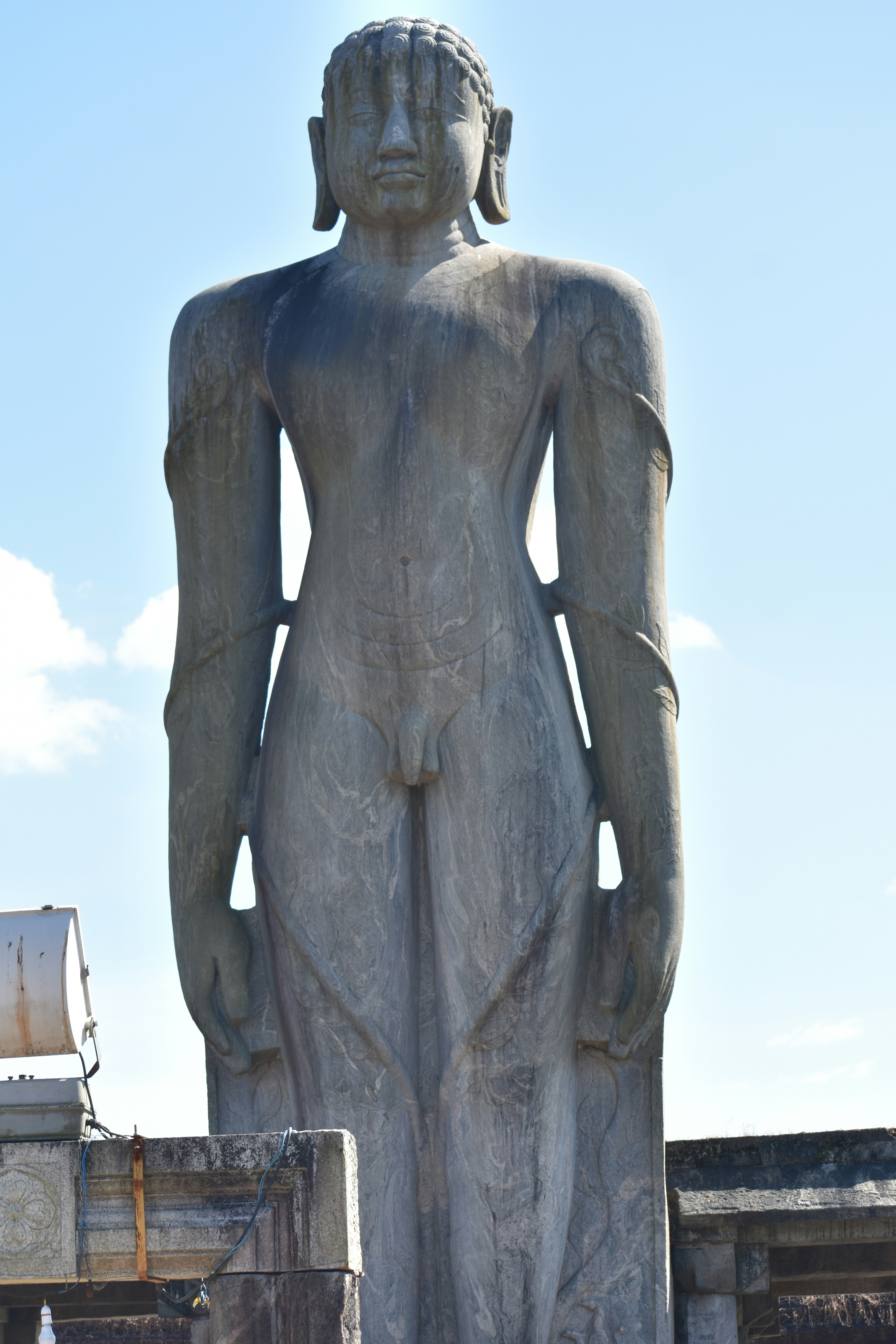 Monolithic Buddha Under Clear Skies: Weathered Stone Standing in Silence