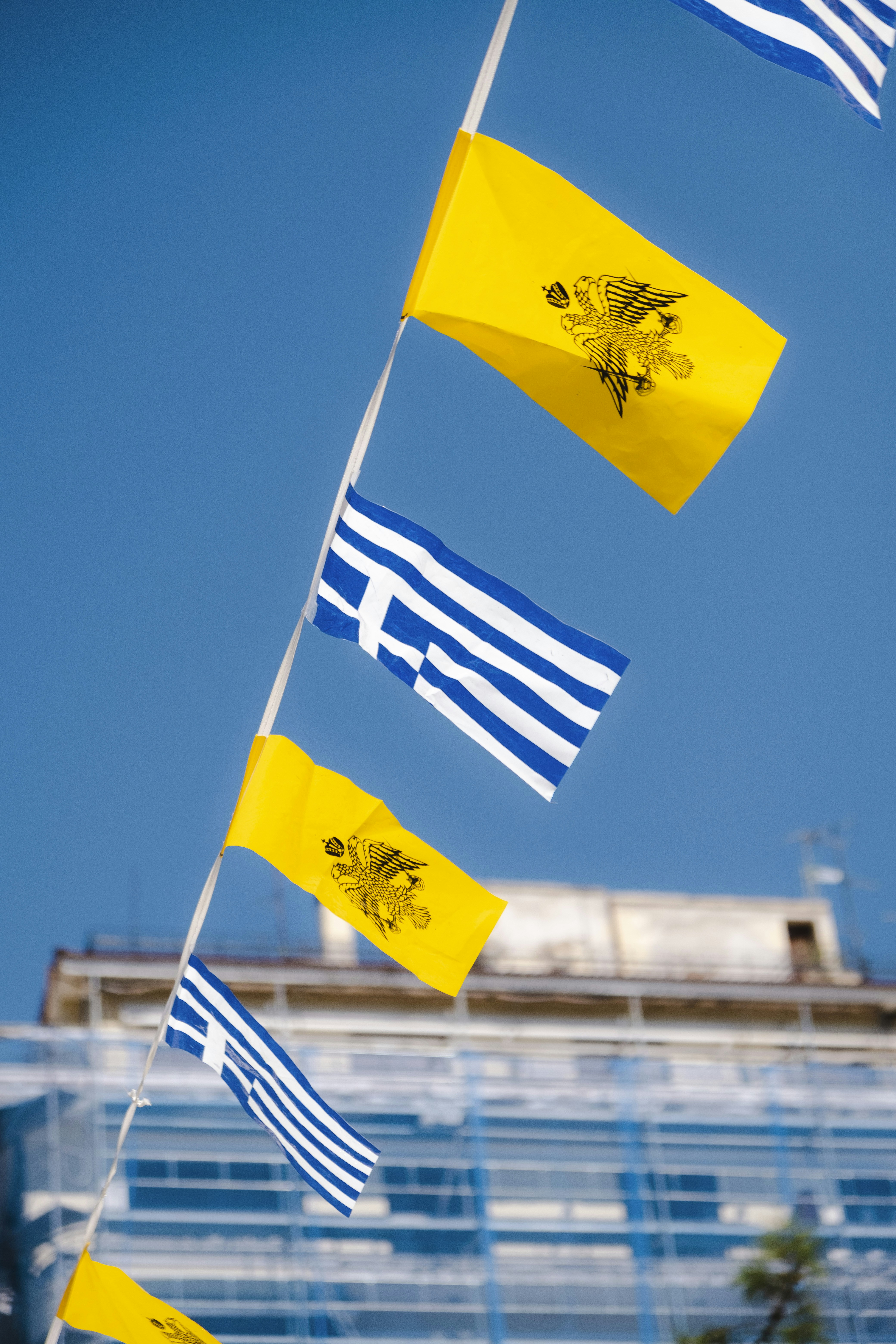 A bunch of flags flying in the wind photo – Free Thessaloniki Image on ...