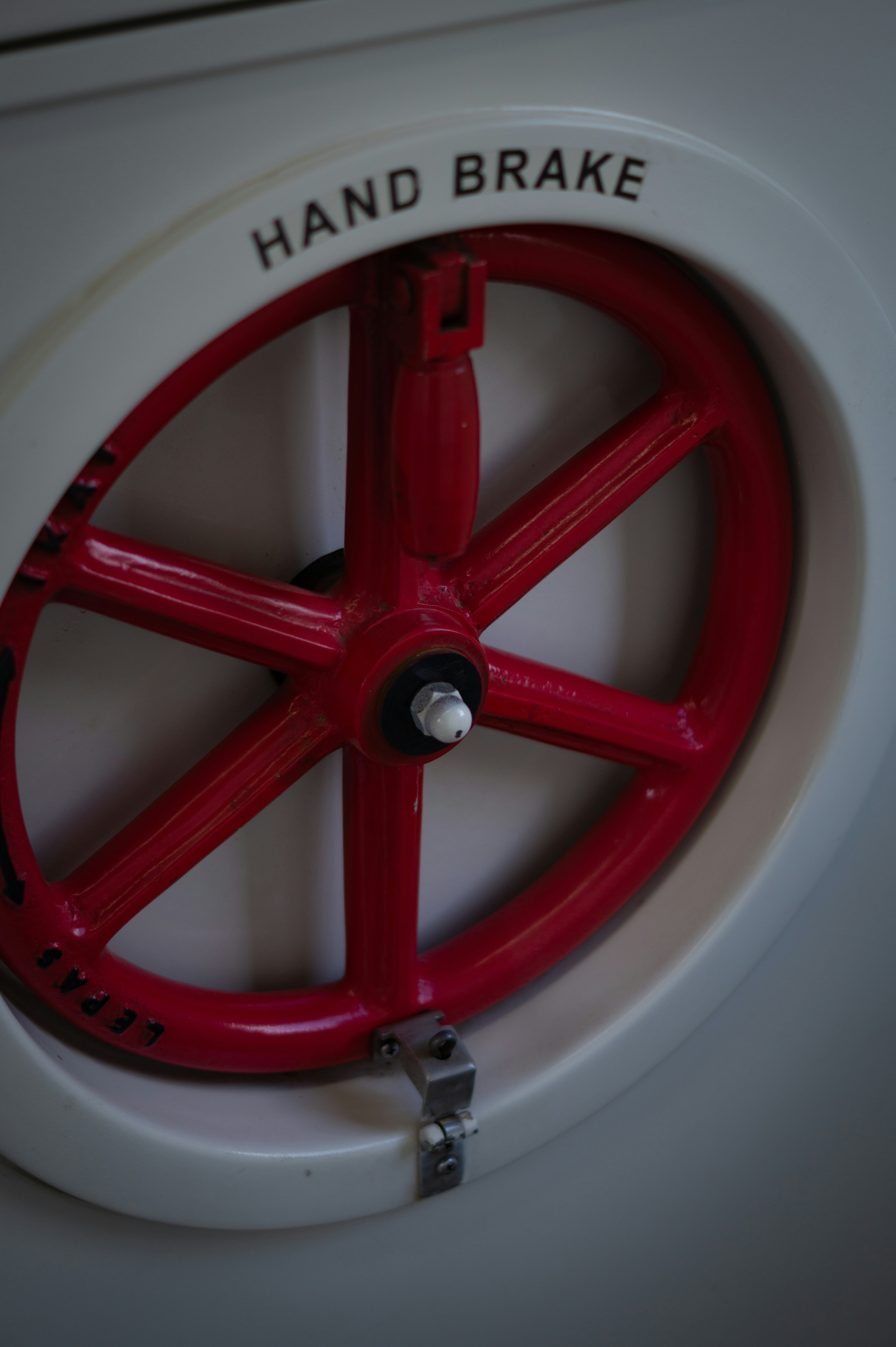 Red Spoked Hand Brake: A Close-Up on a Quarter-Turn Moment
