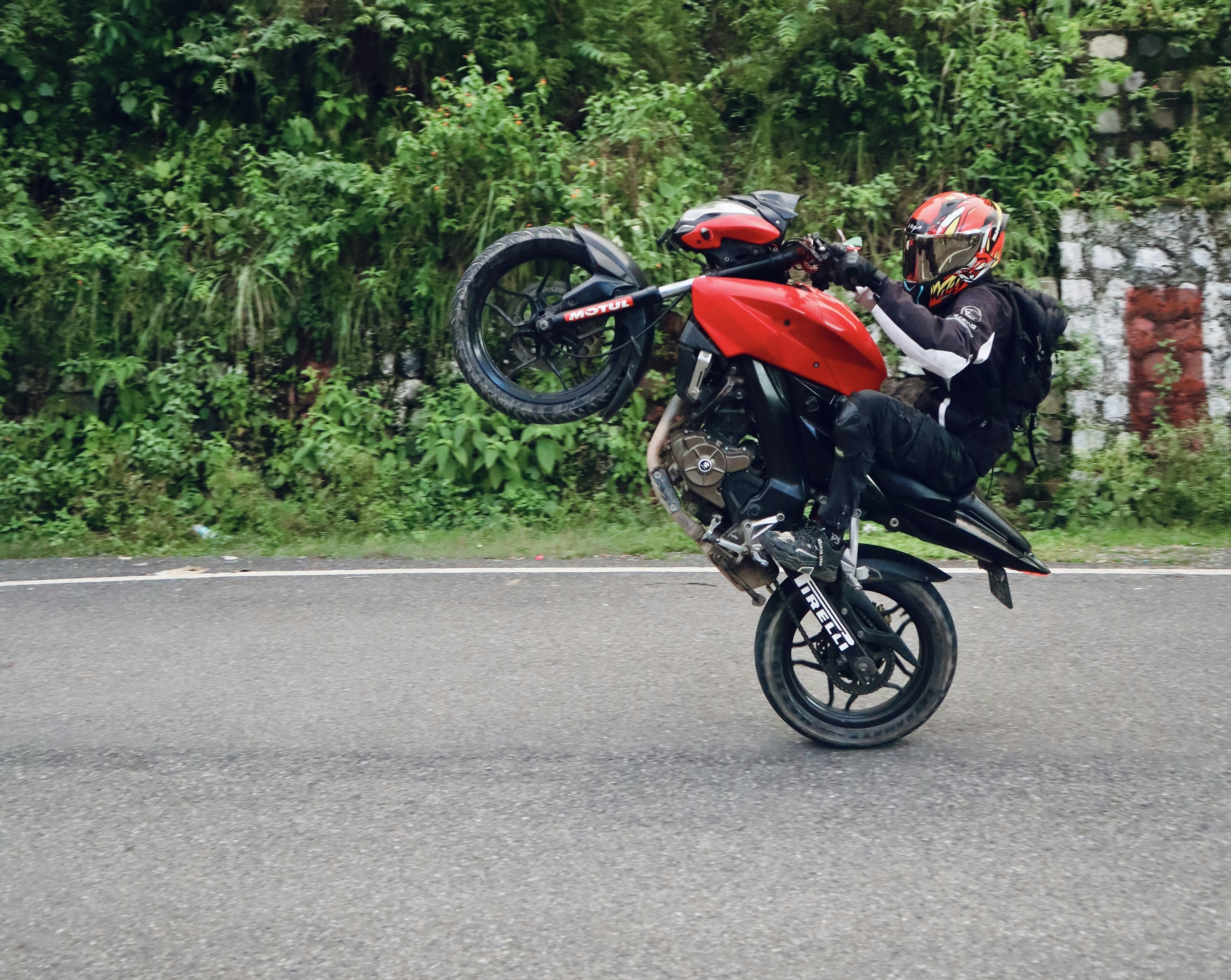 A person on a motorcycle doing a wheelie photo – Free Helmet Image on ...