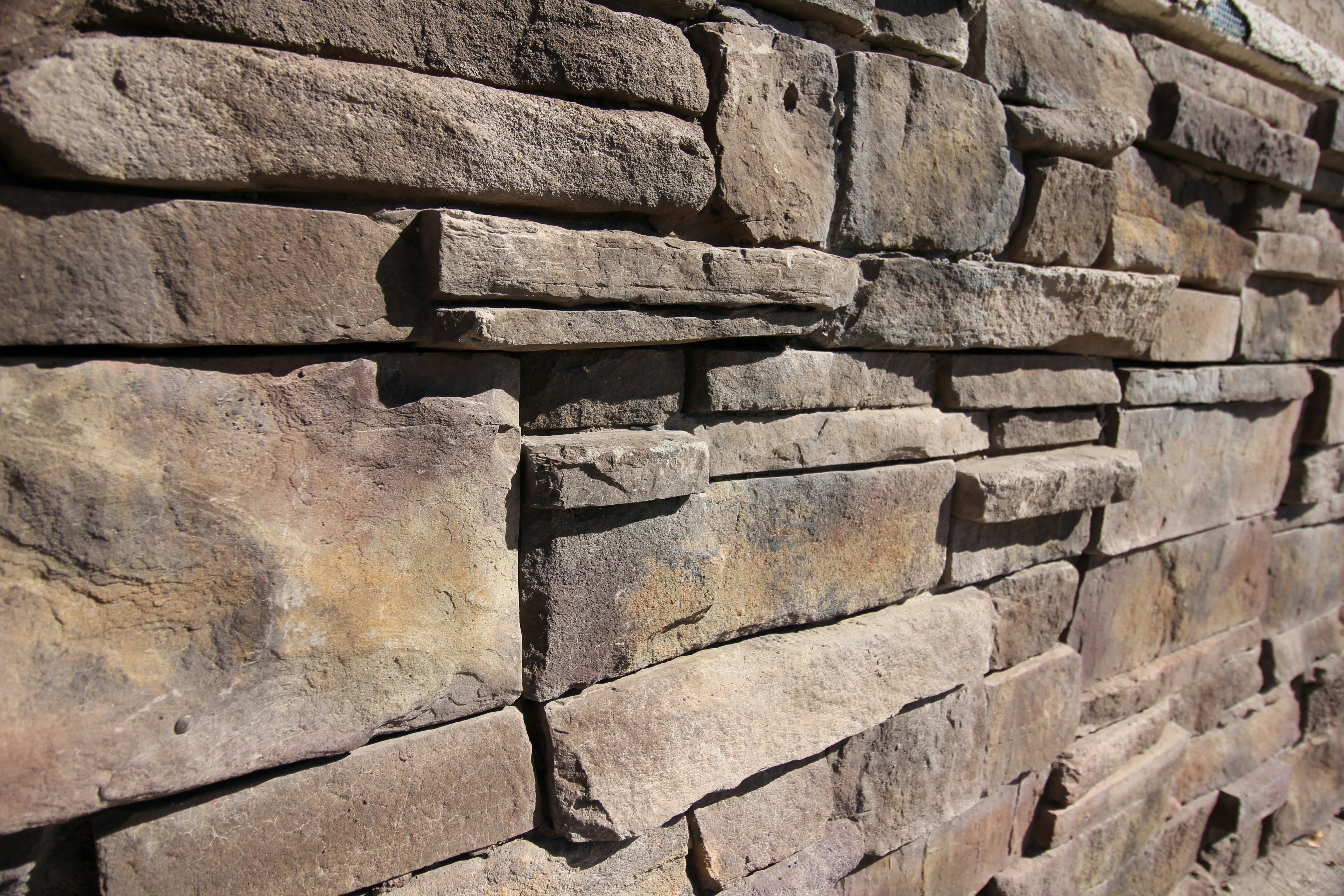 A close up of a stone wall made of bricks photo – Free Building Image ...