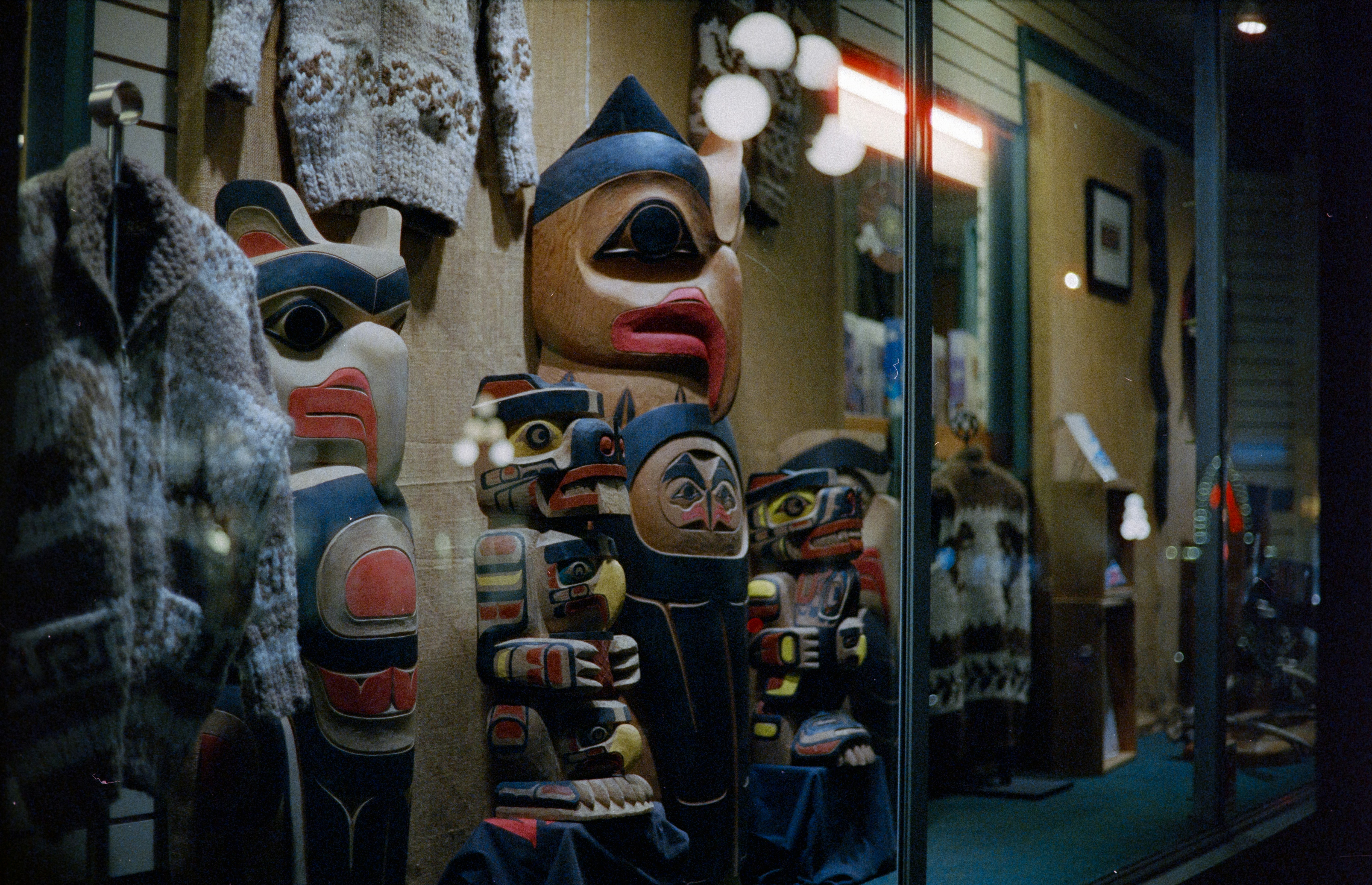 A group of totems on display in a store window photo – Free Victoria ...
