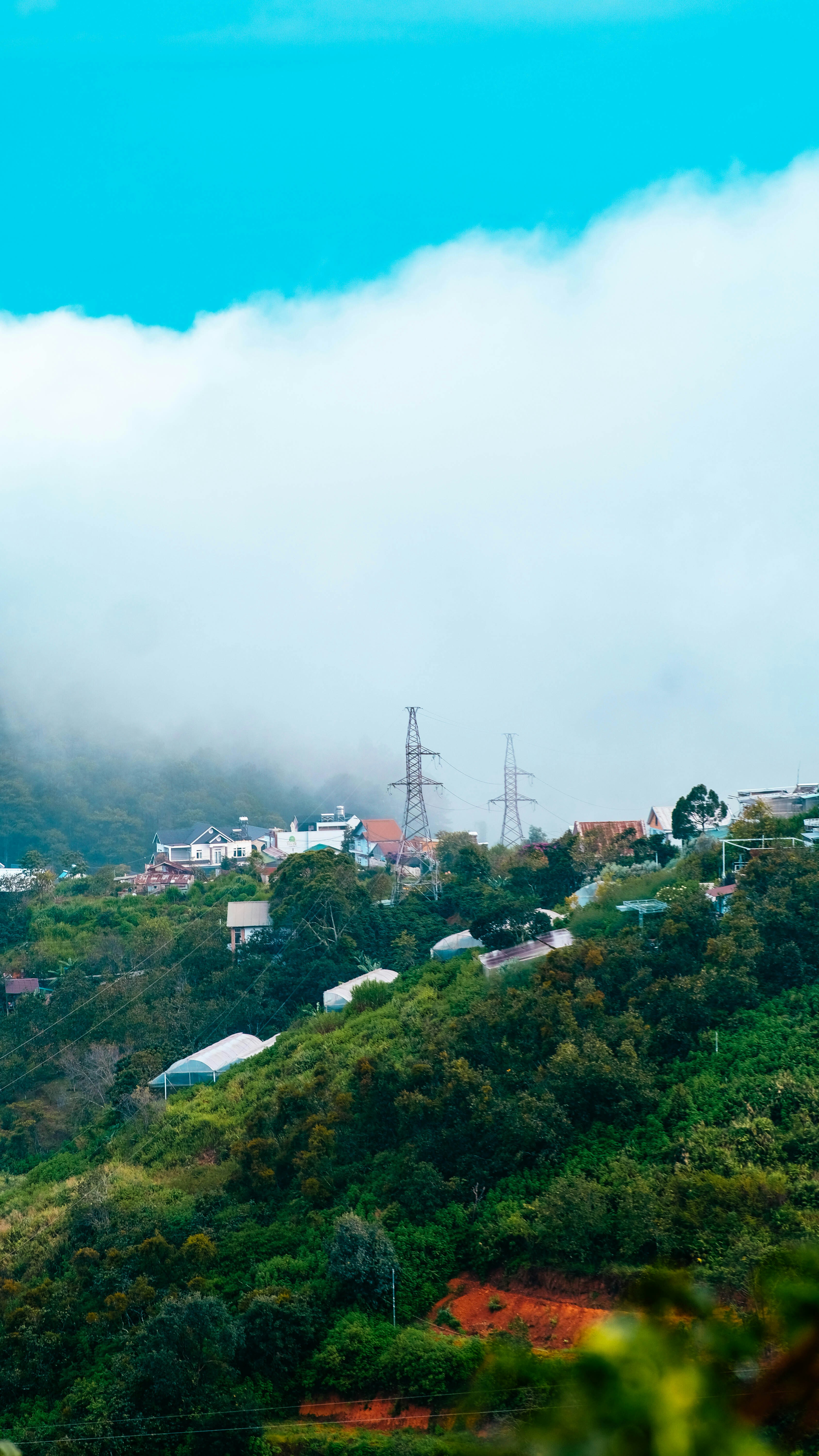 Towers in the Mist: A hillside village under a cobalt sky