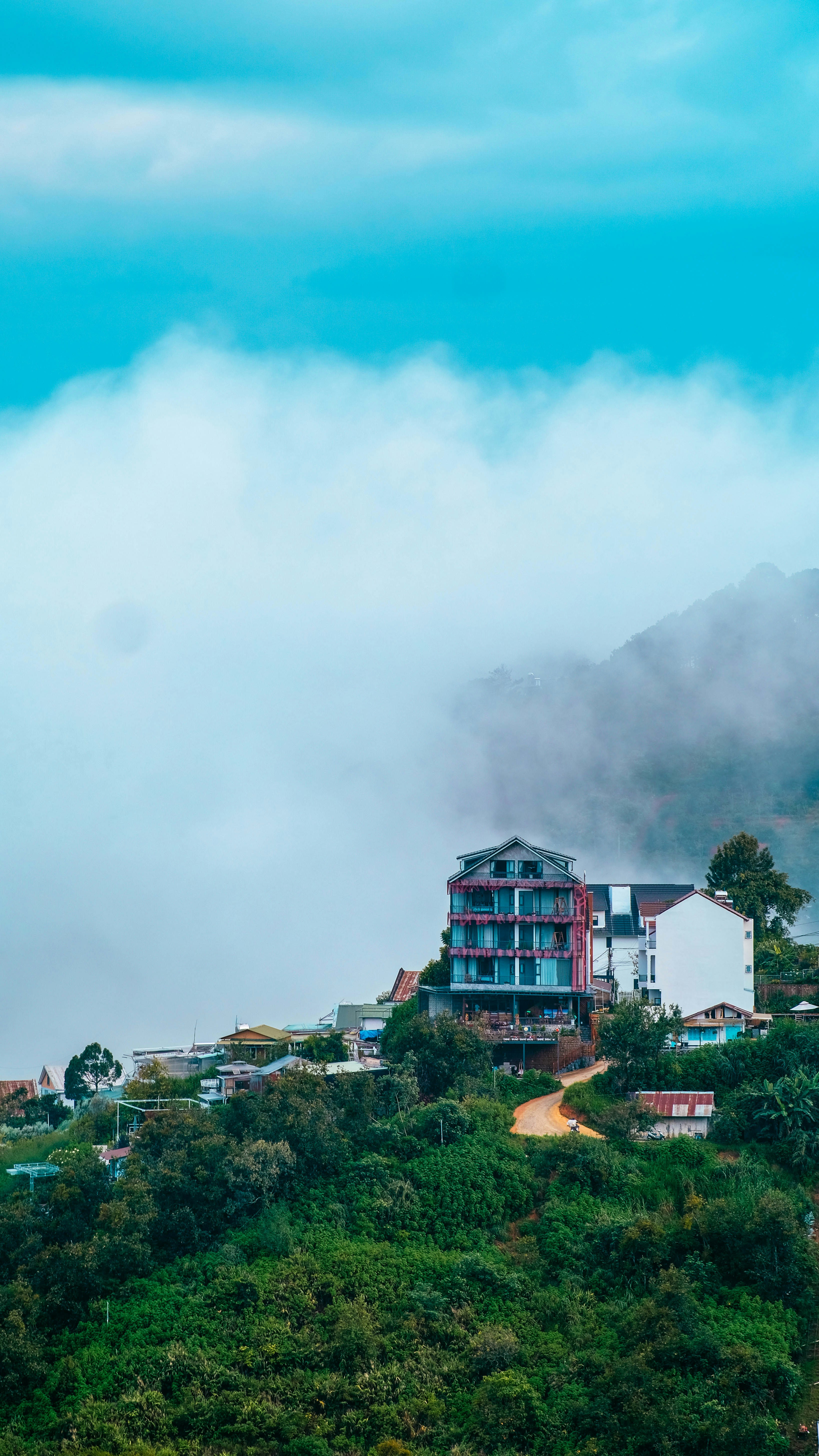 Pink Balconies Rising Through Morning Mist on a Mountain Village