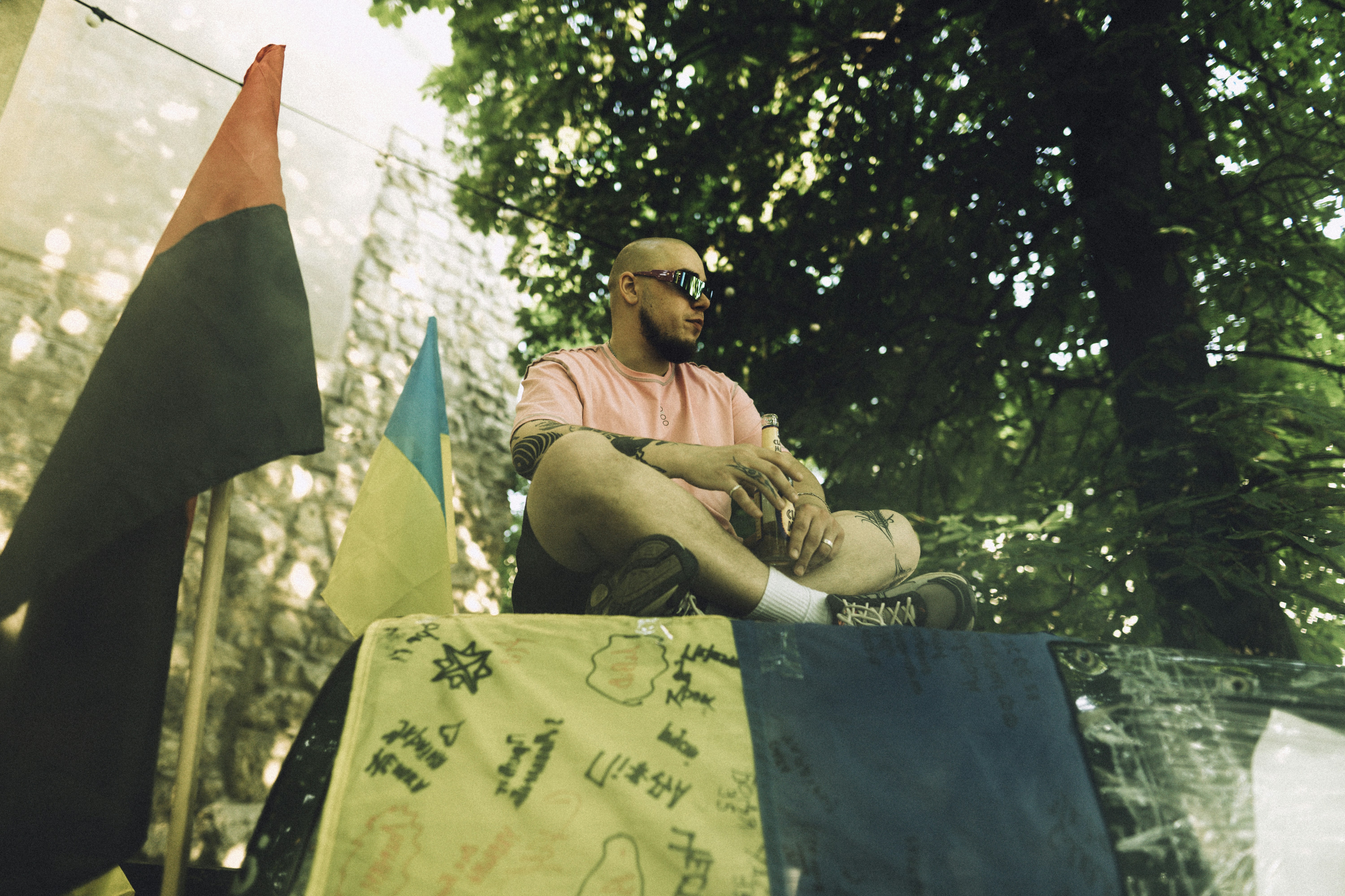 A man sitting on top of a table next to flags photo – Free Portrait ...